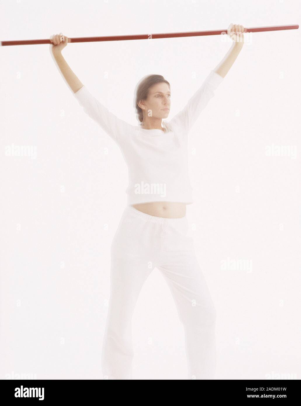 Woman exercising. Woman lifting a bar, rod or the central part of a ...
