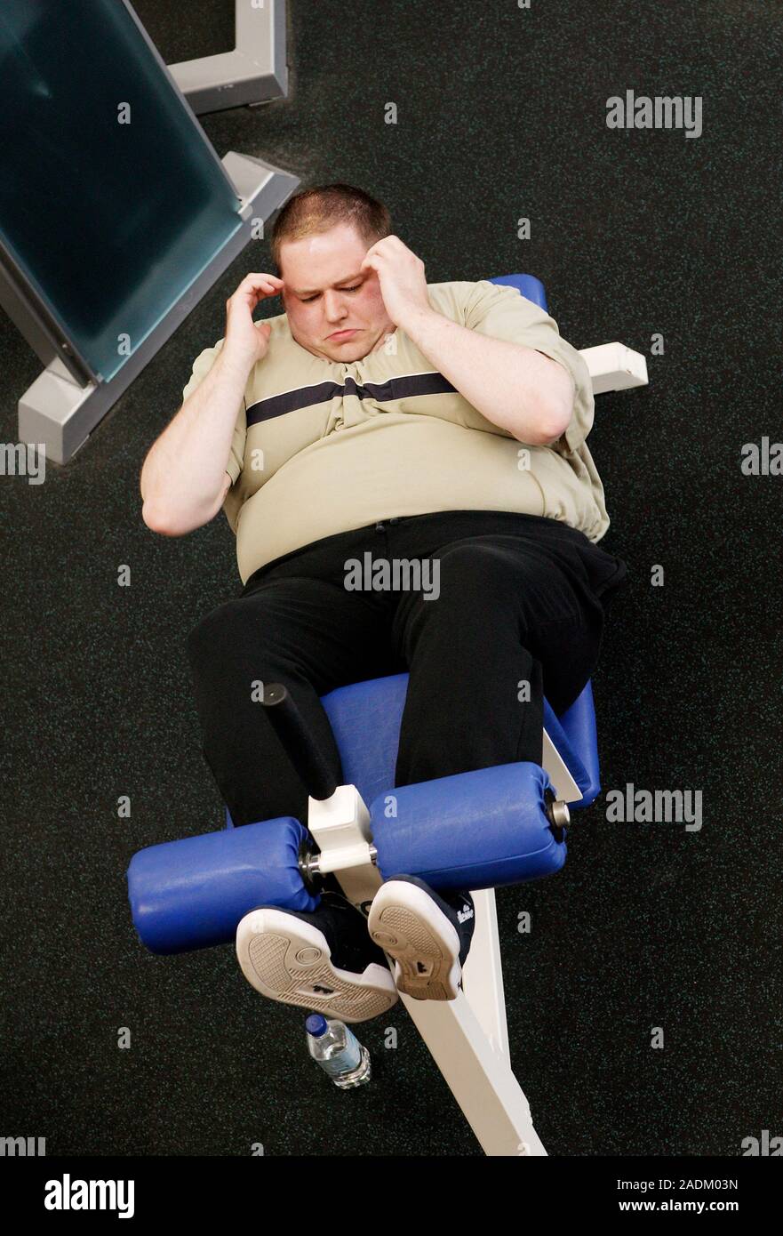 Obese man exercising. Obese man doing sit-ups at a gym Stock Photo - Alamy