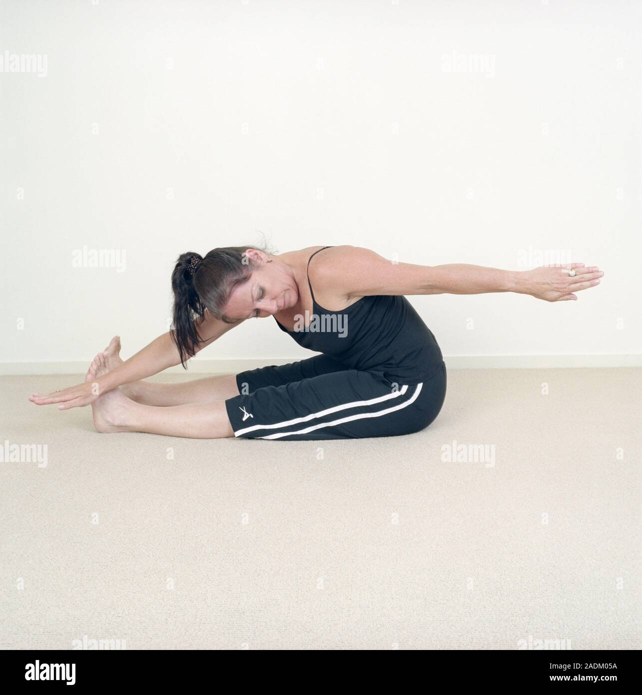 MODEL RELEASED. Pilates exercise. Woman stretching Stock Photo - Alamy