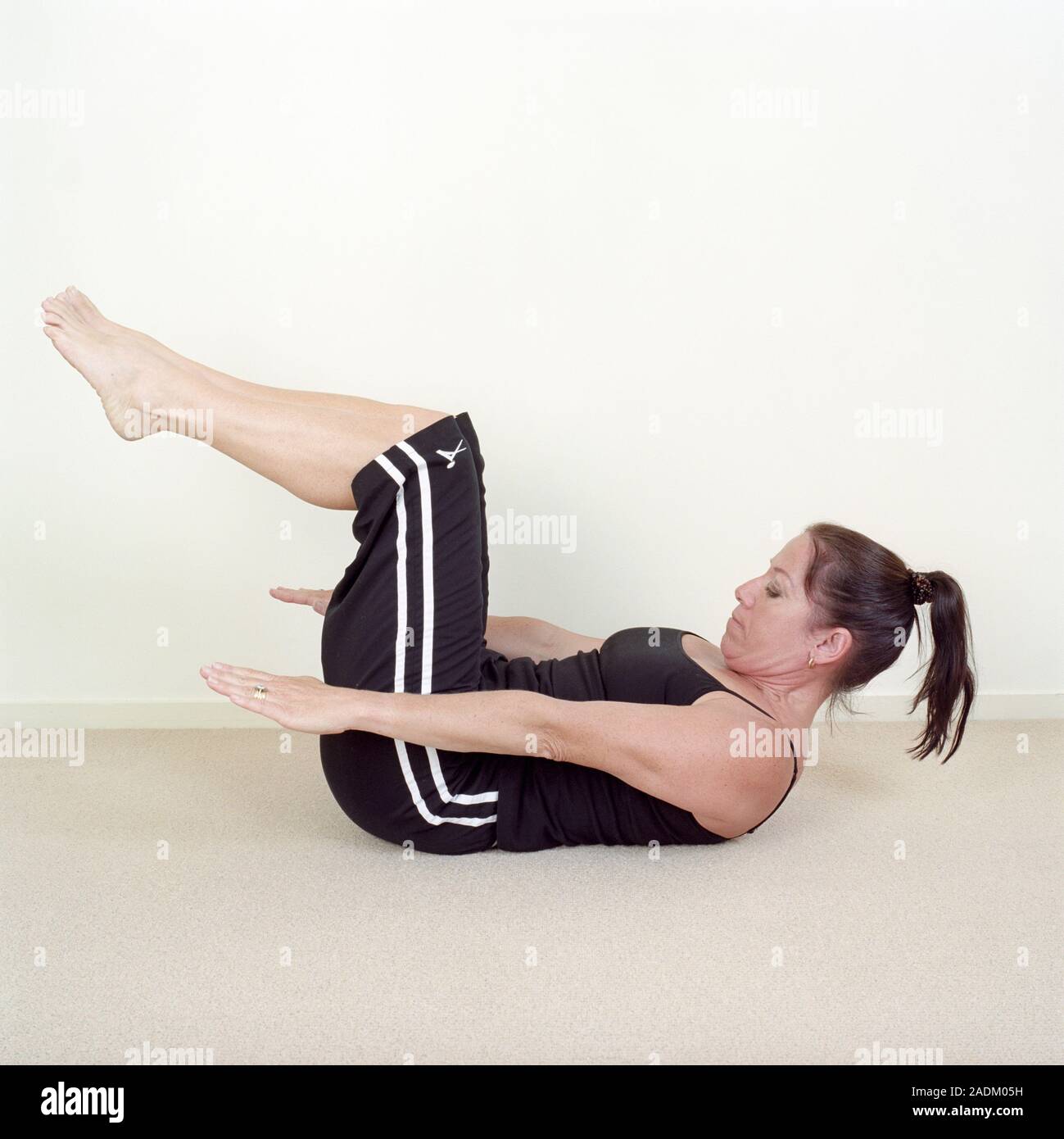 MODEL RELEASED. Pilates exercise. Woman stretching Stock Photo - Alamy