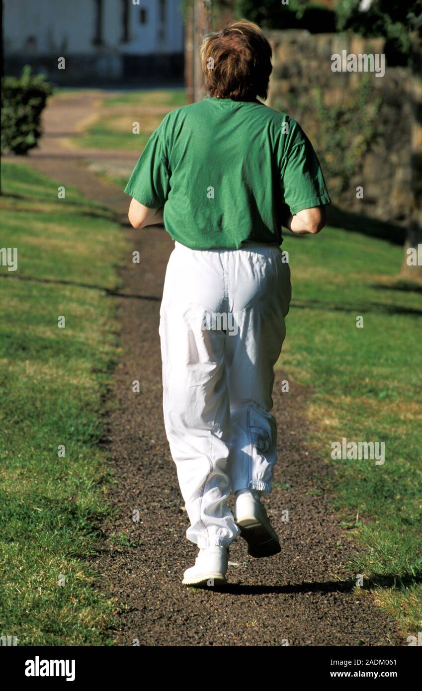 MODEL RELEASED. Man jogging along a path Stock Photo - Alamy