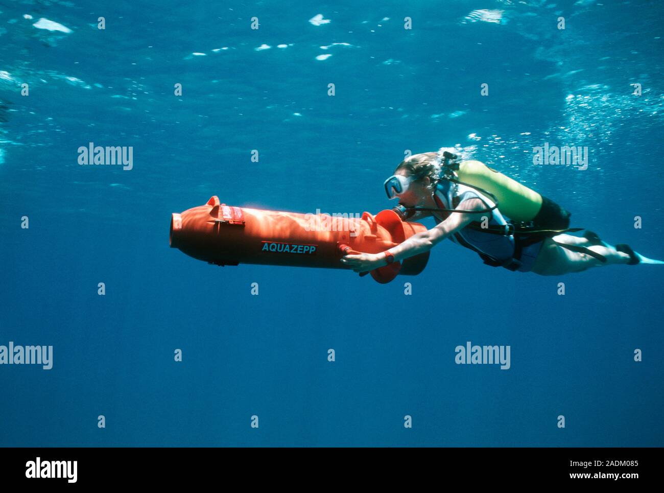 Scuba diver using a Diver Propulsion Vehicle (DPV). The DPV is battery ...