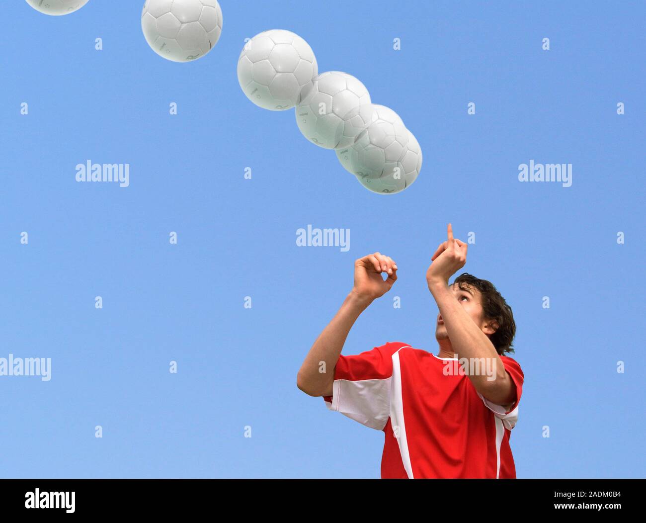 MODEL RELEASED. Header. Composite image of a footballer heading a ball ...