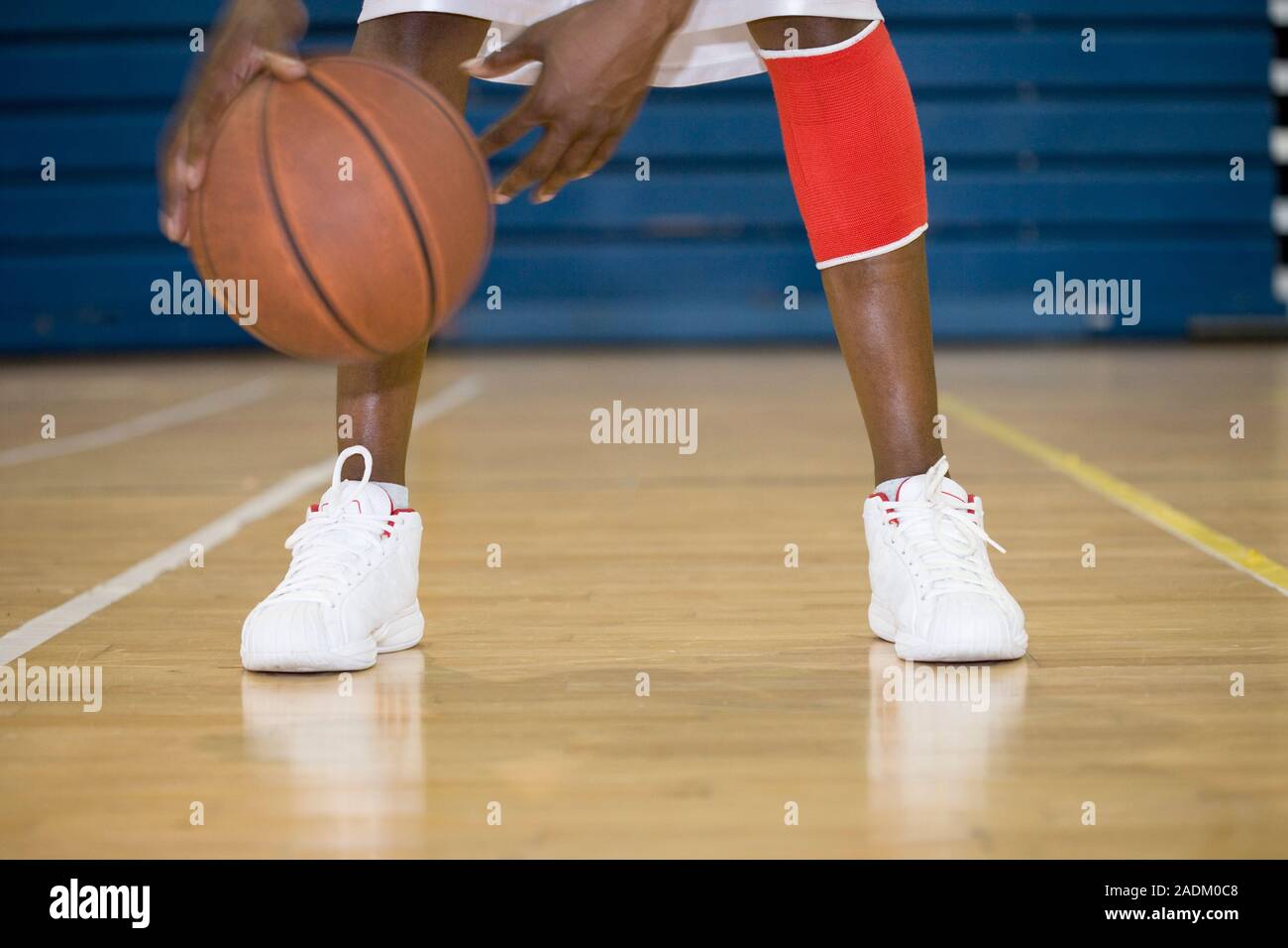 MODEL RELEASED. Basketball player bouncing a ball Stock Photo - Alamy