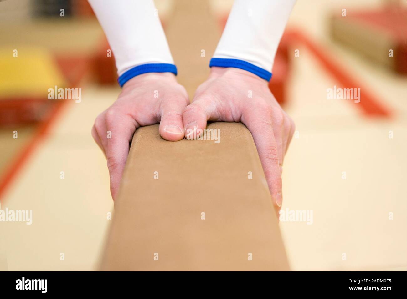 MODEL RELEASED. Gymnasts hands gripping a beam Stock Photo - Alamy
