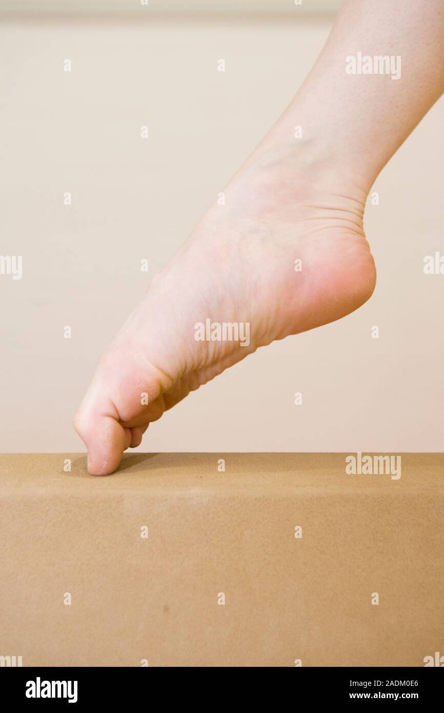 MODEL RELEASED. Gymnast pointing her toes. This technique is important ...