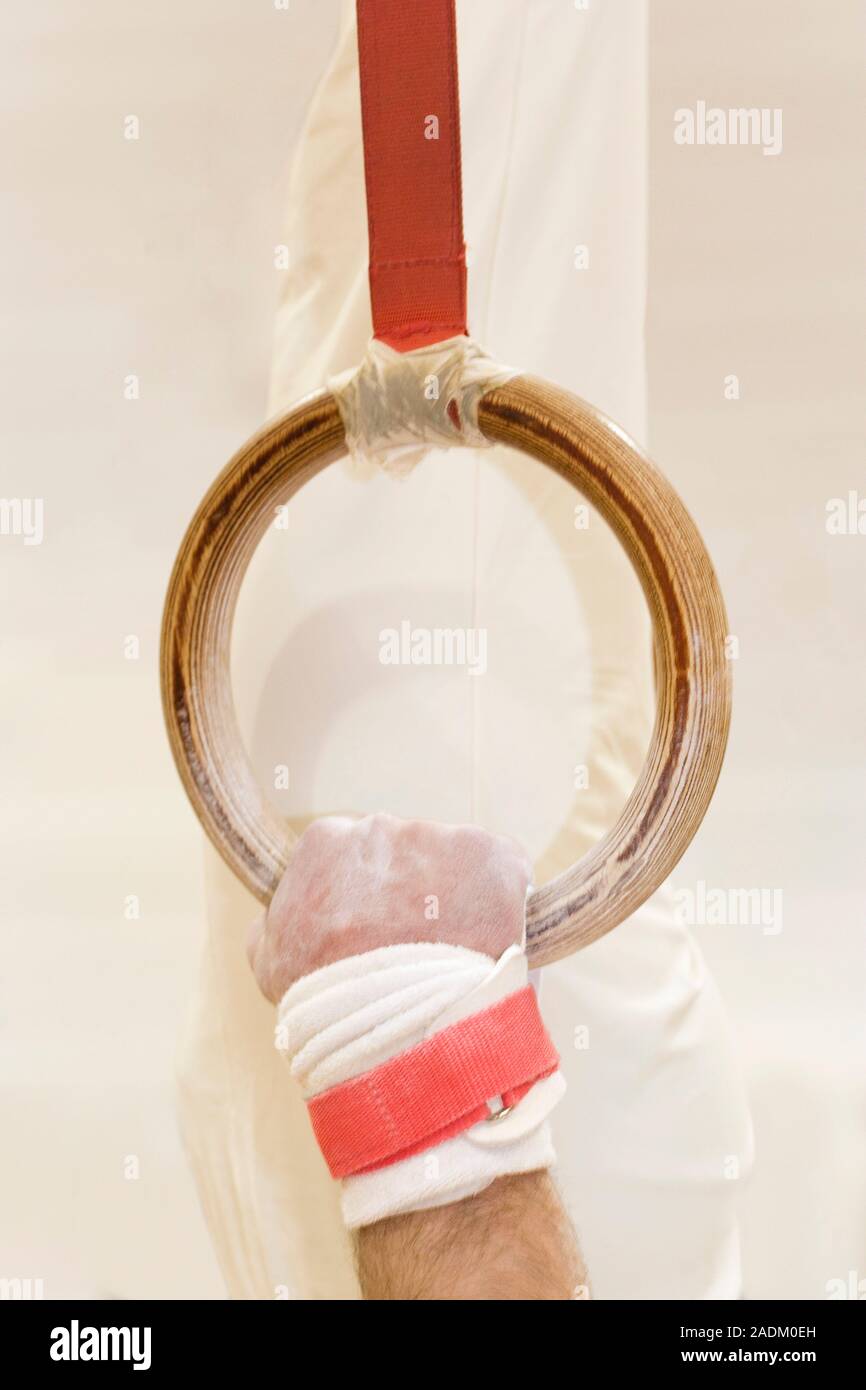 MODEL RELEASED. Gymnast gripping a ring. This piece of gymnastic ...