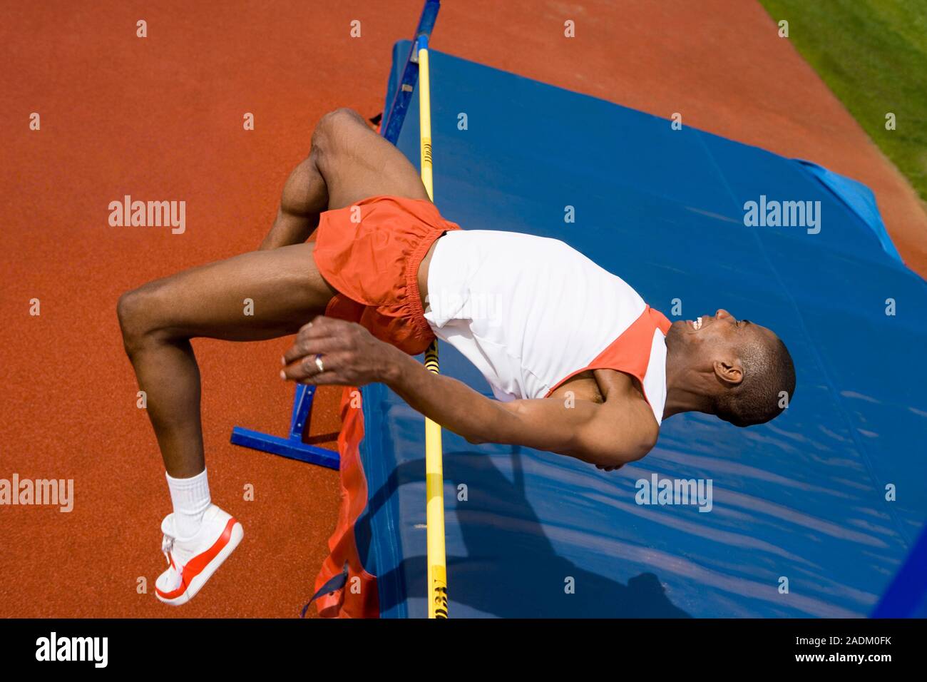 MODEL RELEASED. Athlete performing a high jump. This is a track and ...