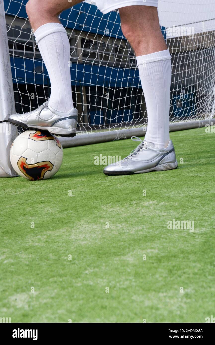 MODEL RELEASED. Footballer in goal Stock Photo - Alamy