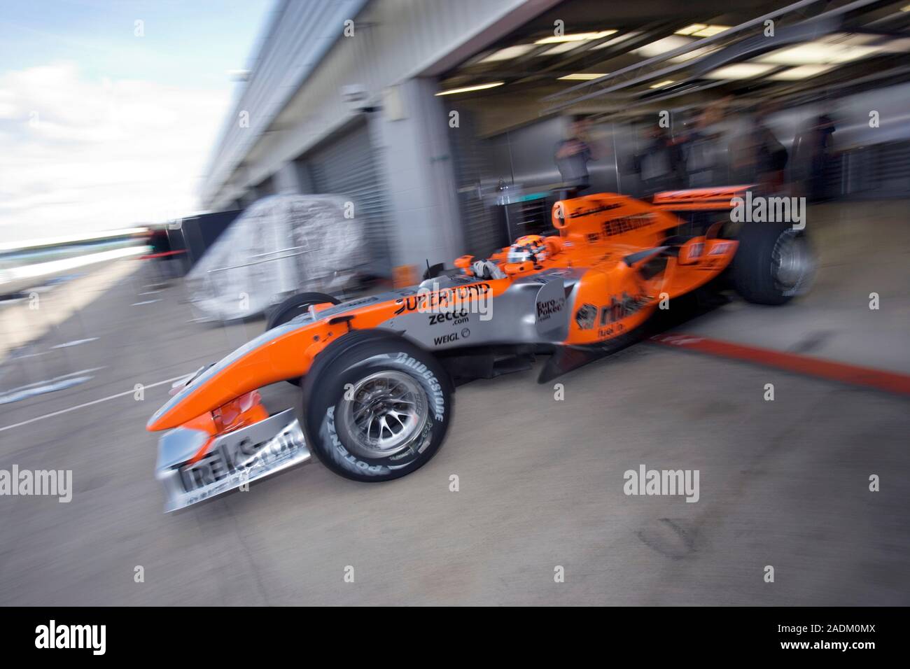 MODEL RELEASED. Formula One racing car exiting the pit garage at a race ...