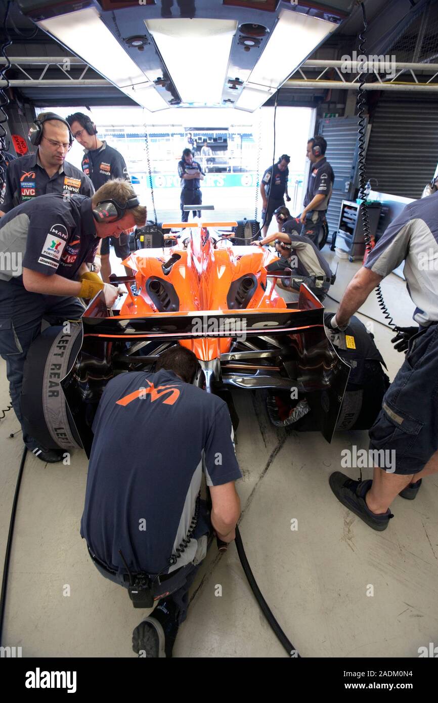 MODEL RELEASED. Formula One racing. Pit crew making adjustments to a ...