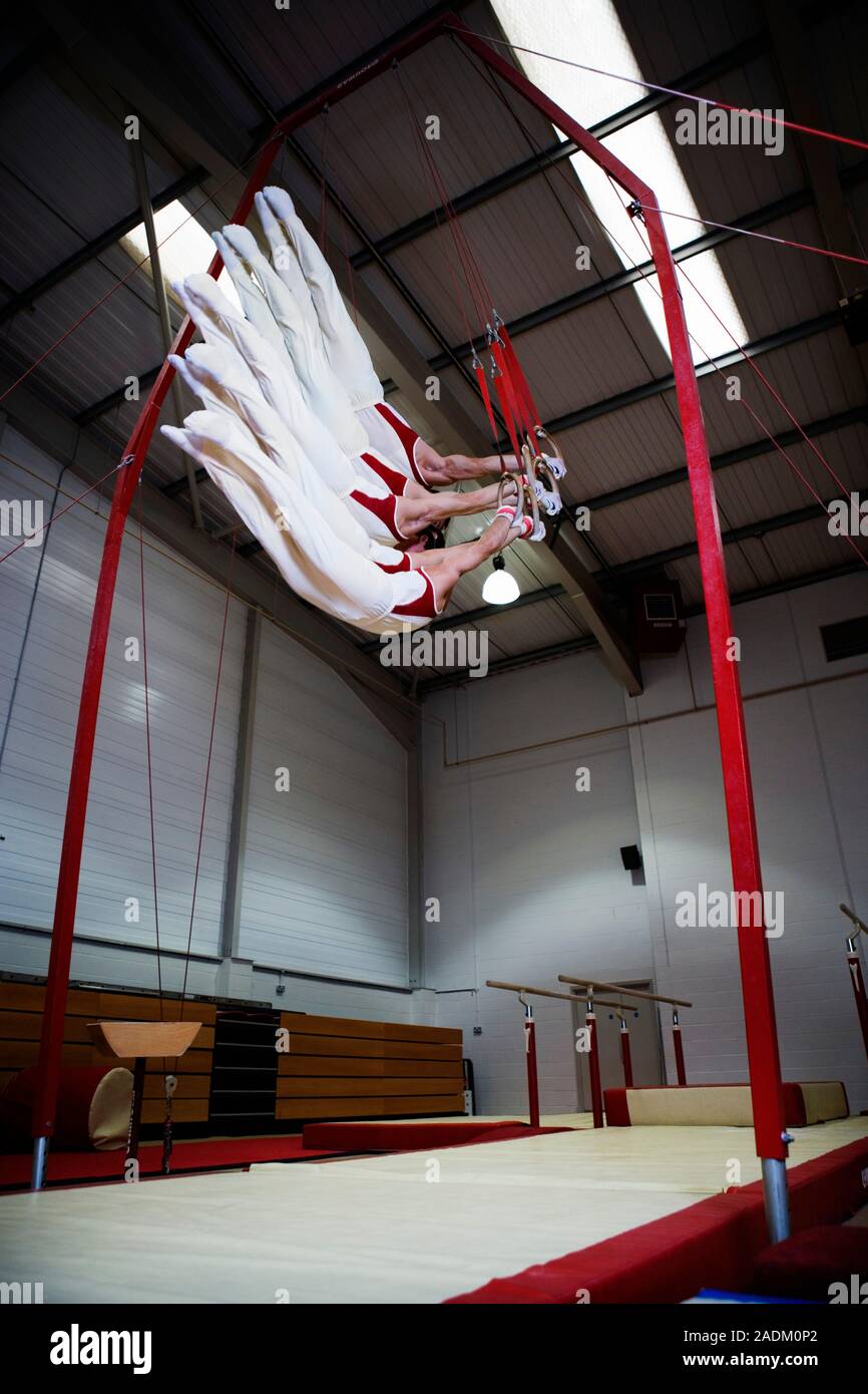 MODEL RELEASED. Gymnast performing on rings. Composite high-speed ...