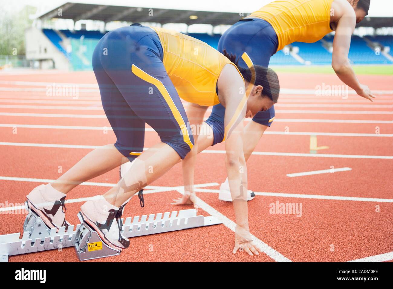 MODEL RELEASED. Athlete leaving the blocks. Composite high-speed ...