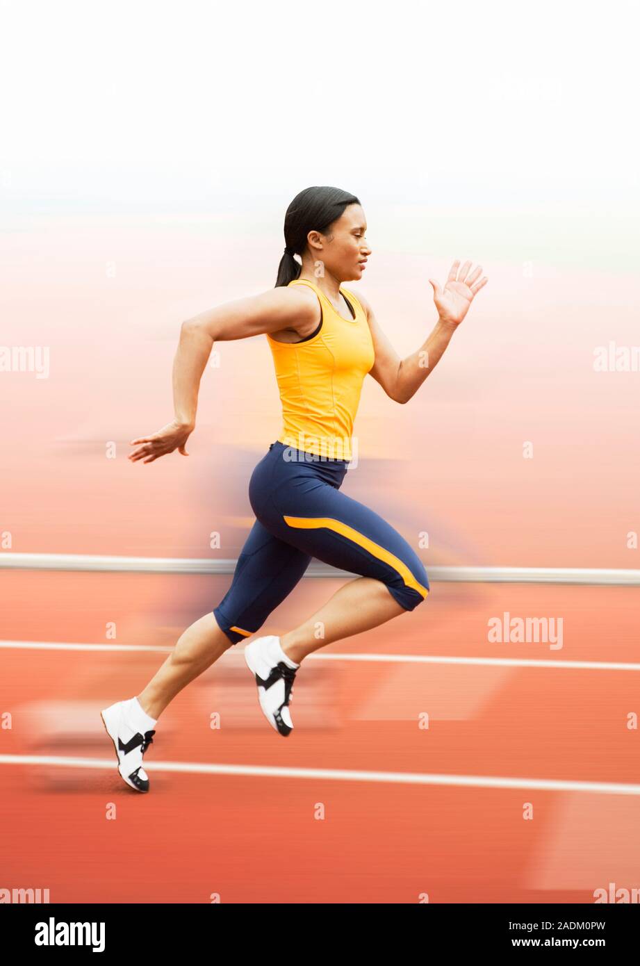 MODEL RELEASED. Sprinter running on a race track Stock Photo - Alamy