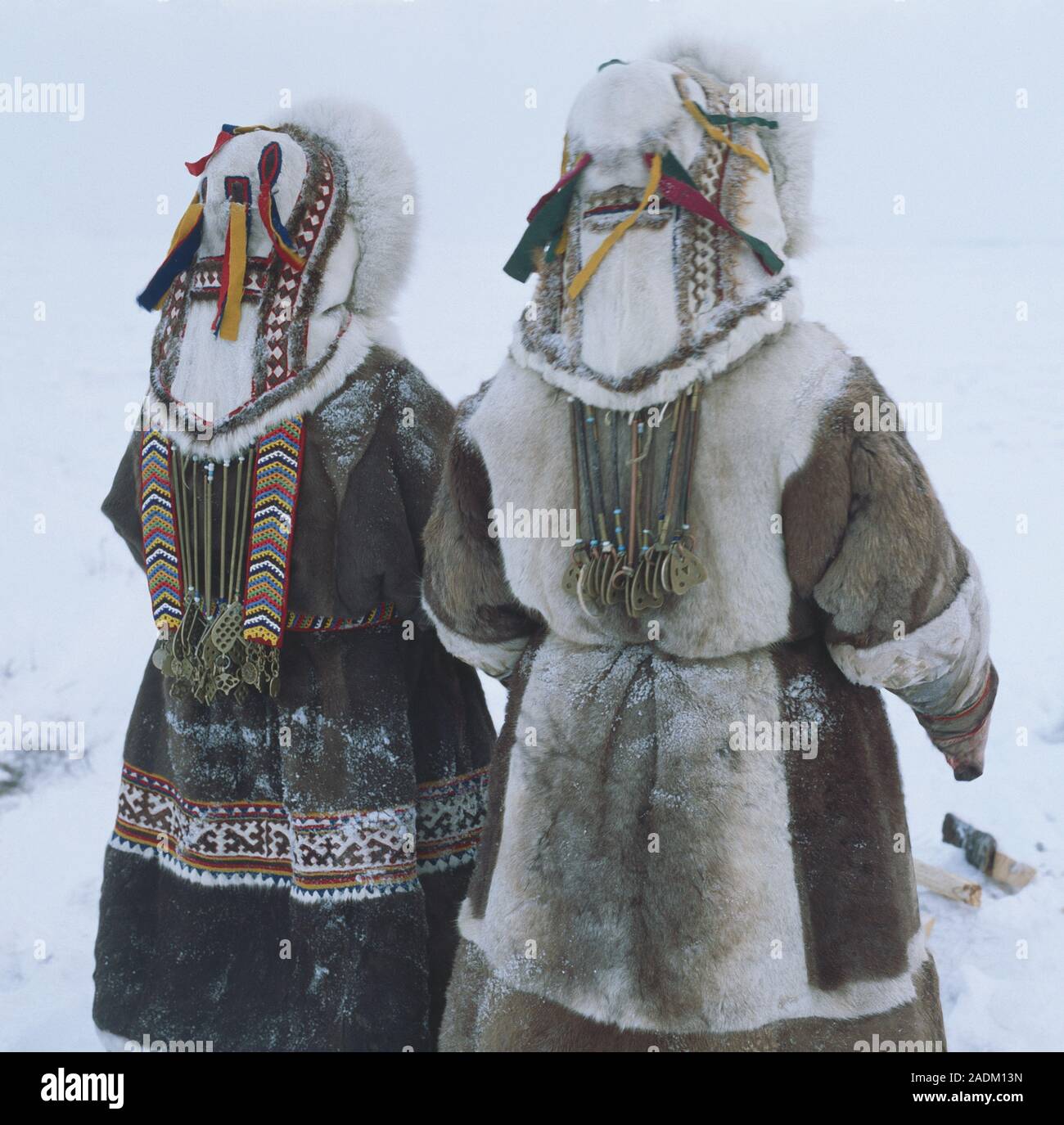 Nenet tribespeople in traditional clothing made from animal skins ...