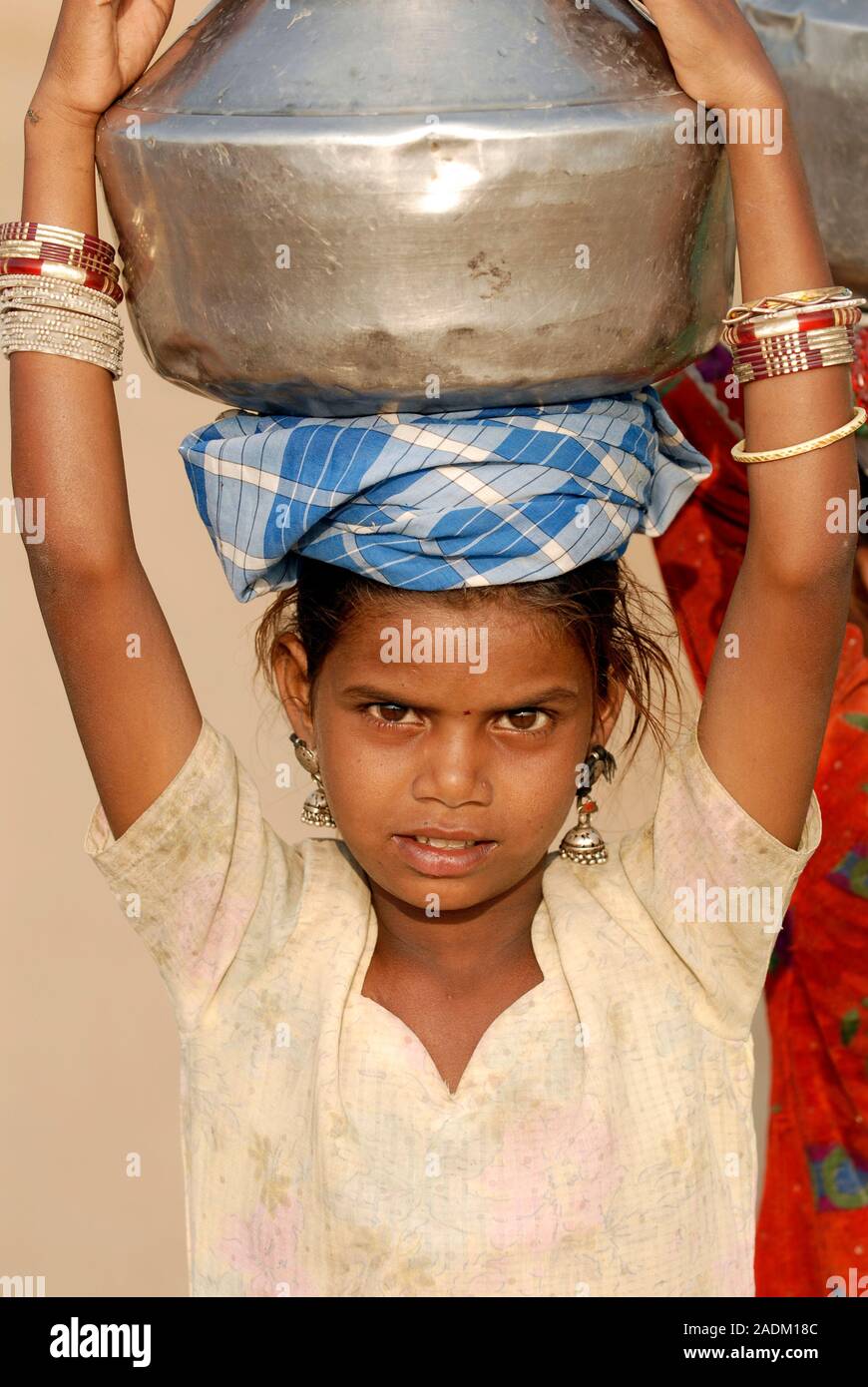 Girl carrying water in a copper pot on her head. Photographed in ...