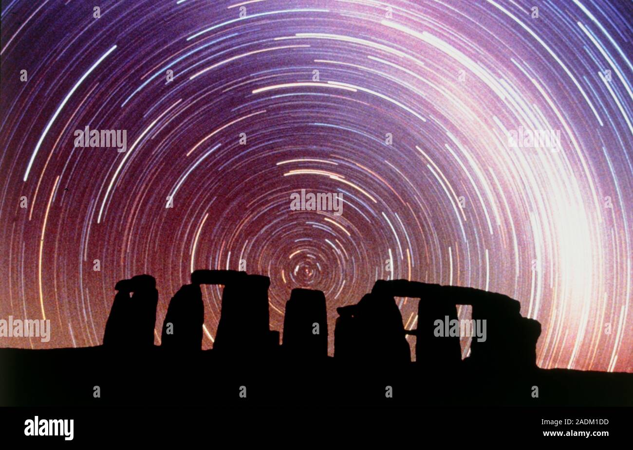 Stonehenge. Composite image of star trails over the silhouetted stones ...