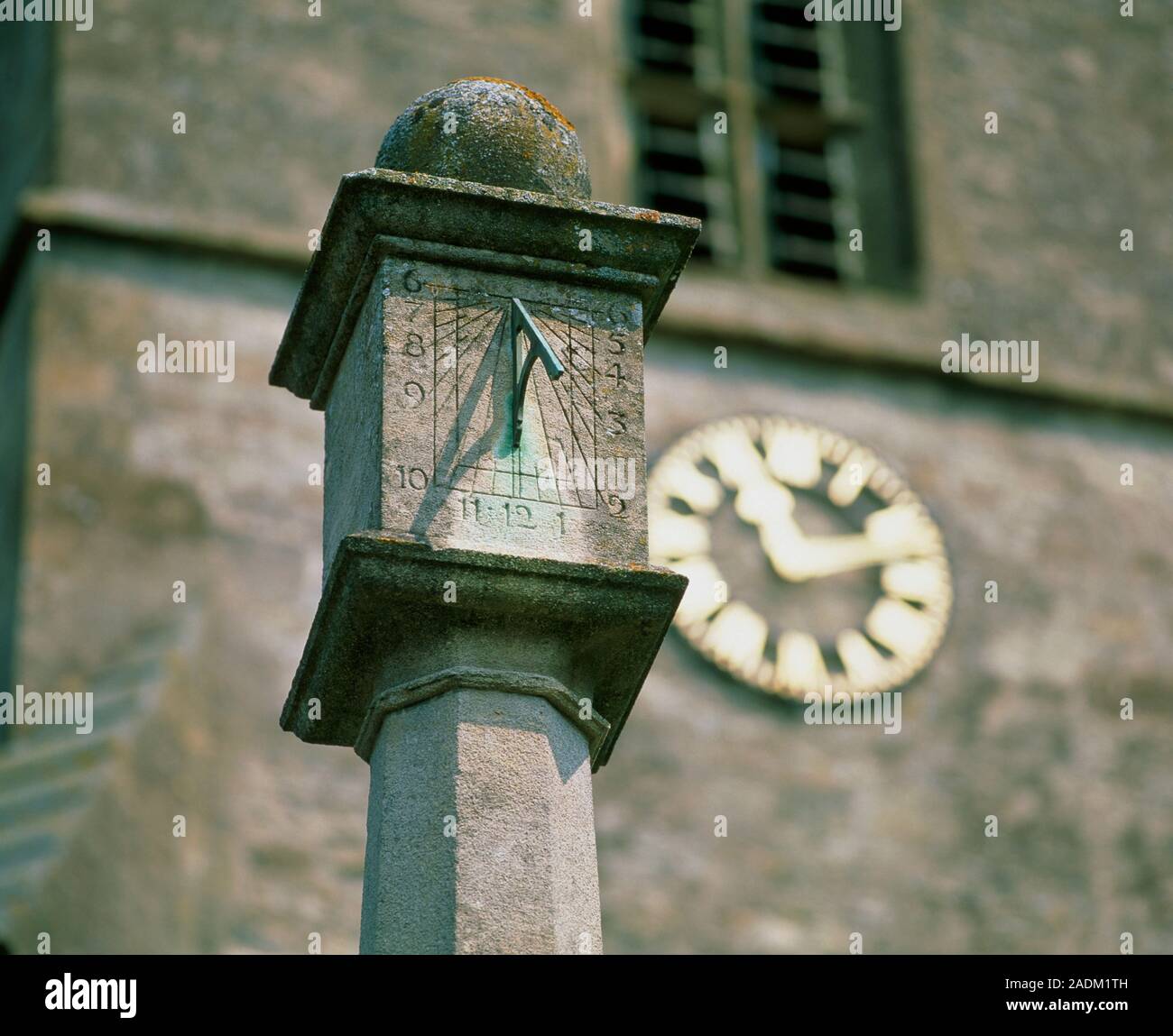 Sundial. Sundial on top of a column in sunlight. Also seen in the ...