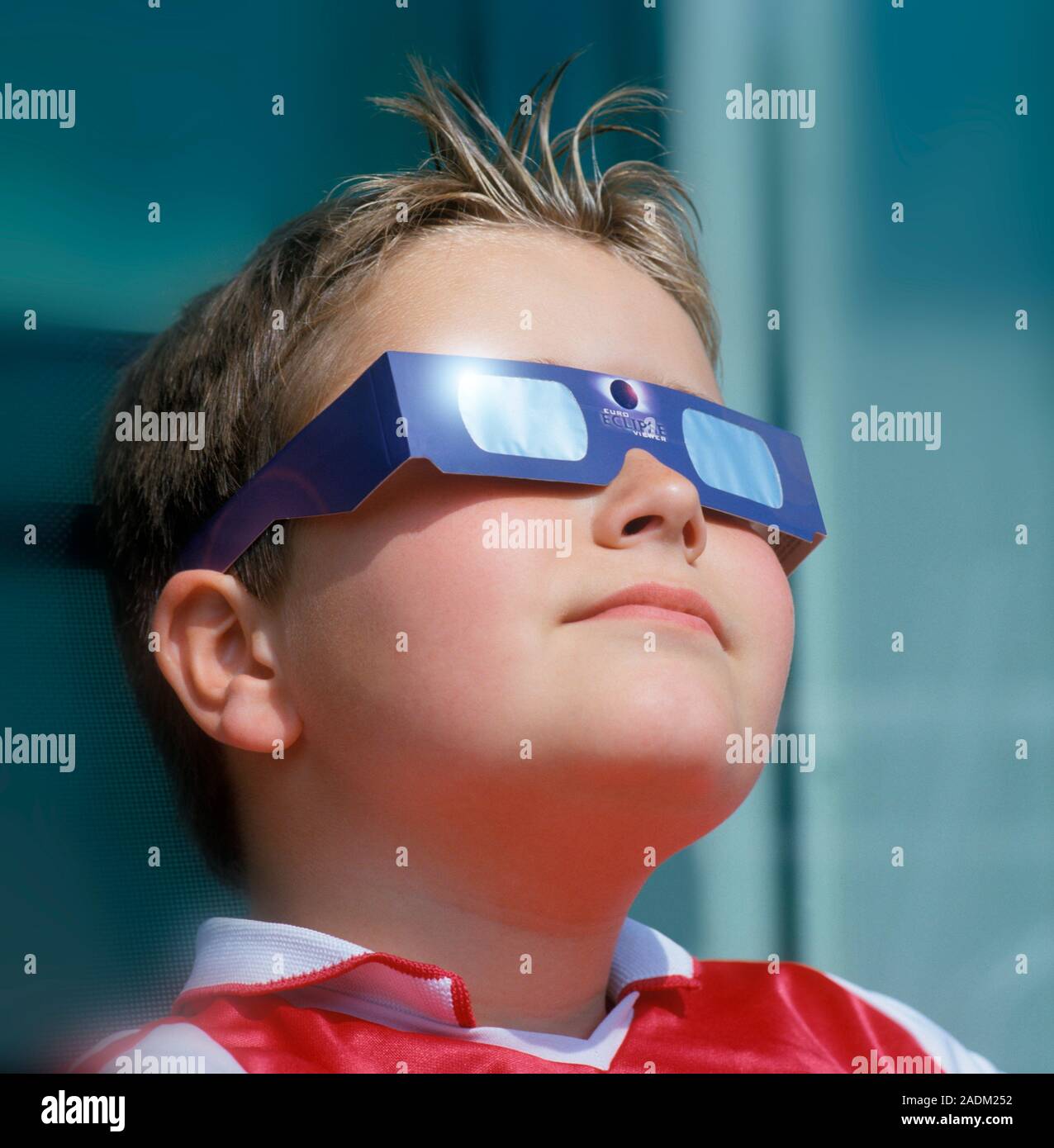 Watching solar eclipse. Young boy using a special protective viewer to ...