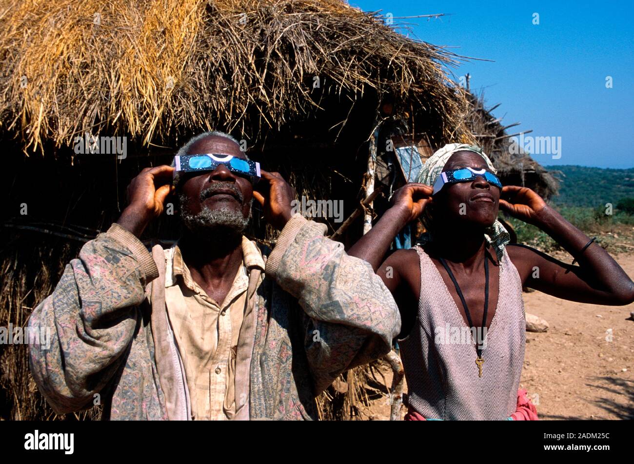 Watching a solar eclipse. Man and woman using special protective ...