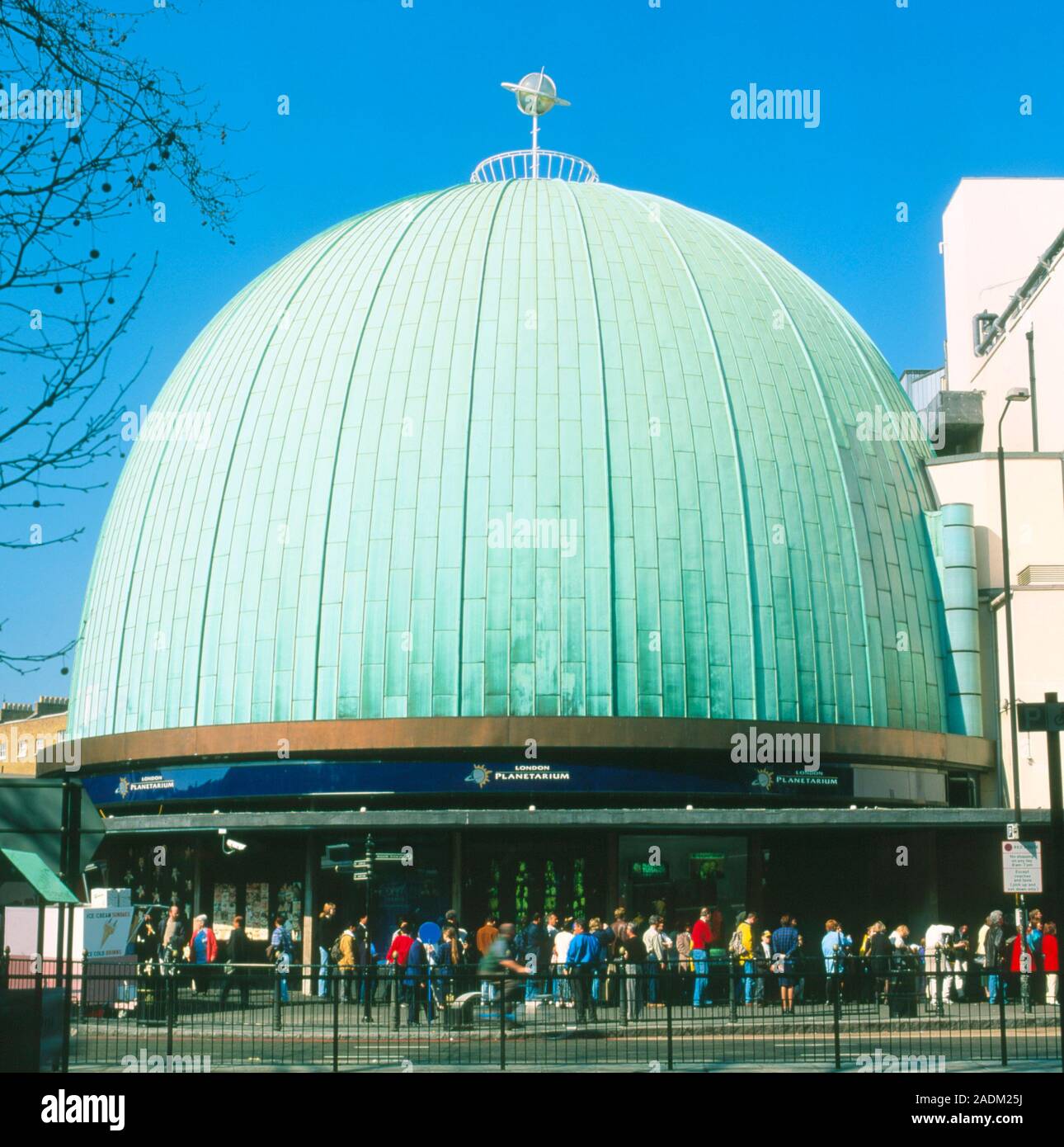 Copper planetarium dome. View of people queuing outside the London ...