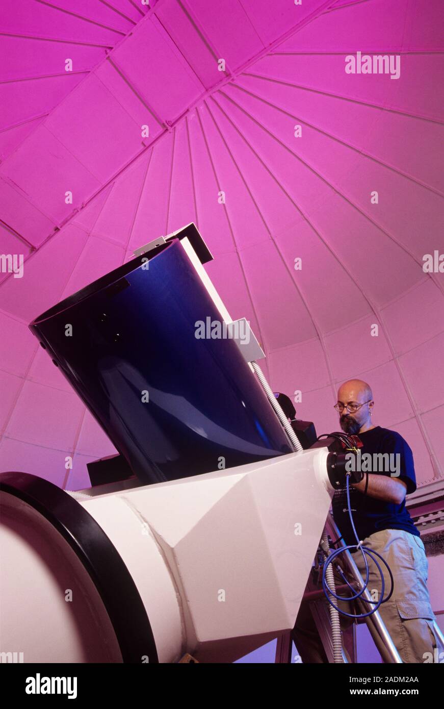 Optical telescope. Researcher checking the optical telescope at the ...