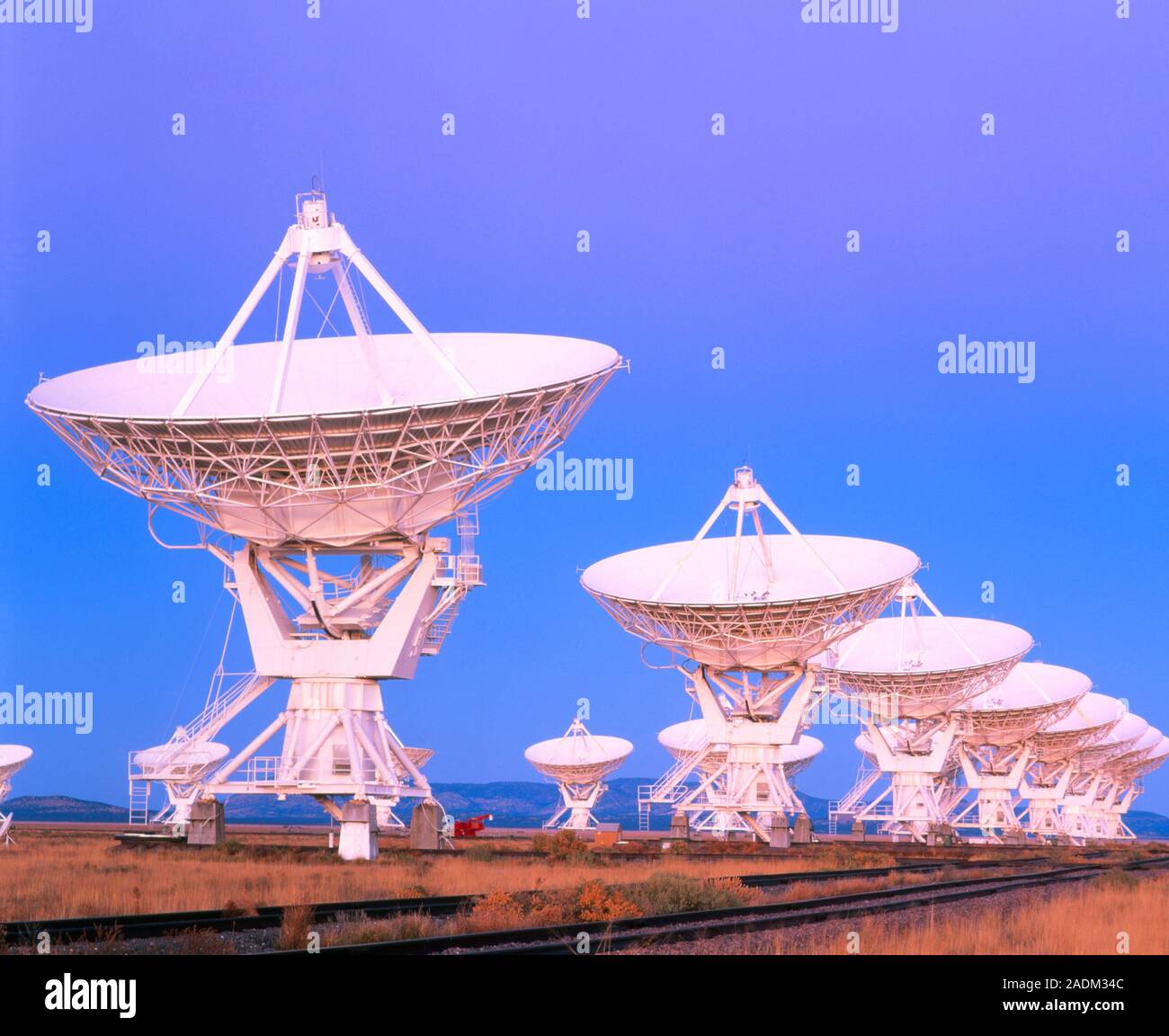 Very Large Array antennae. View of a row of several dish antennae which ...
