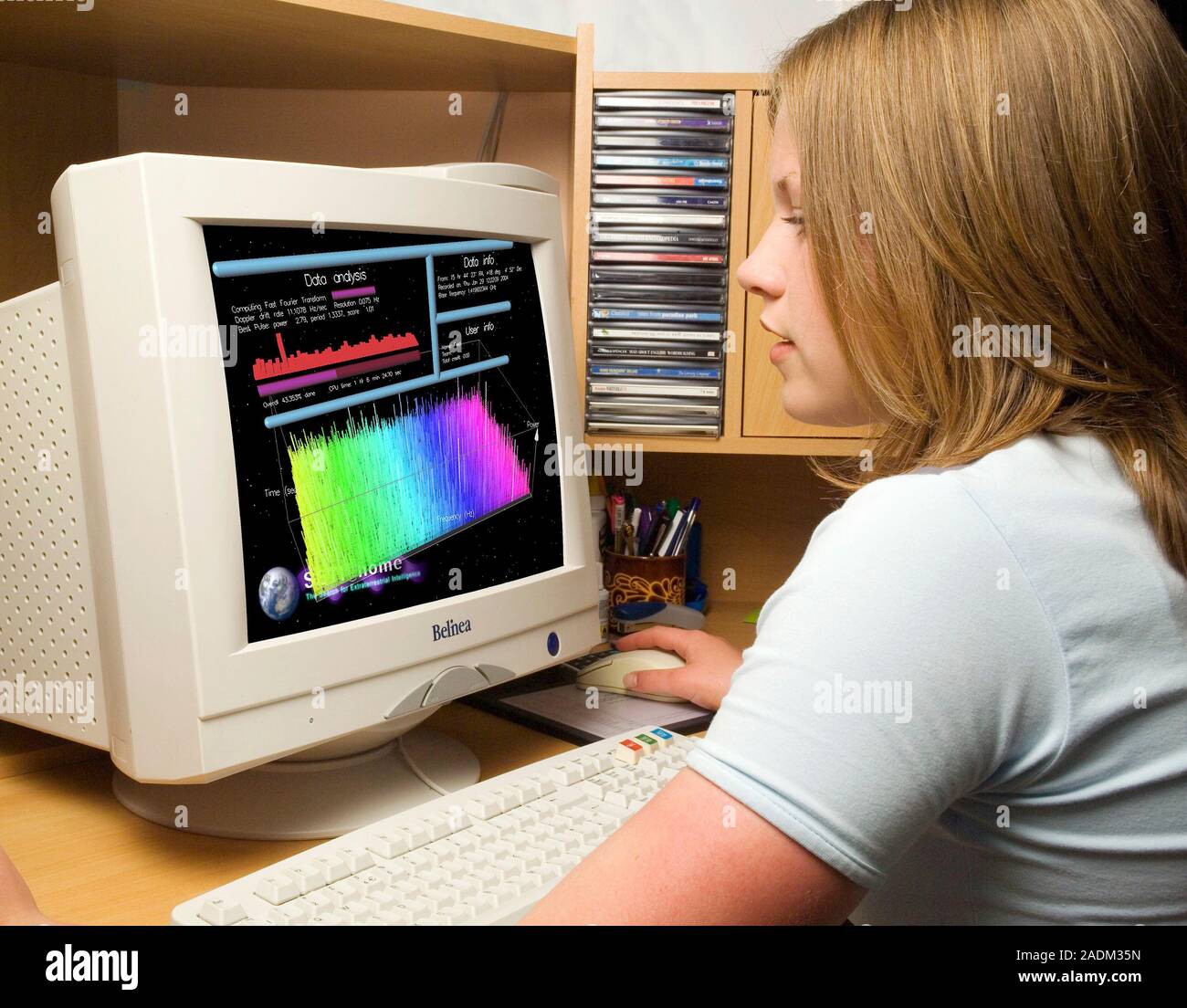 SETI screen saver. Teenage girl sitting in front of a computer with a ...
