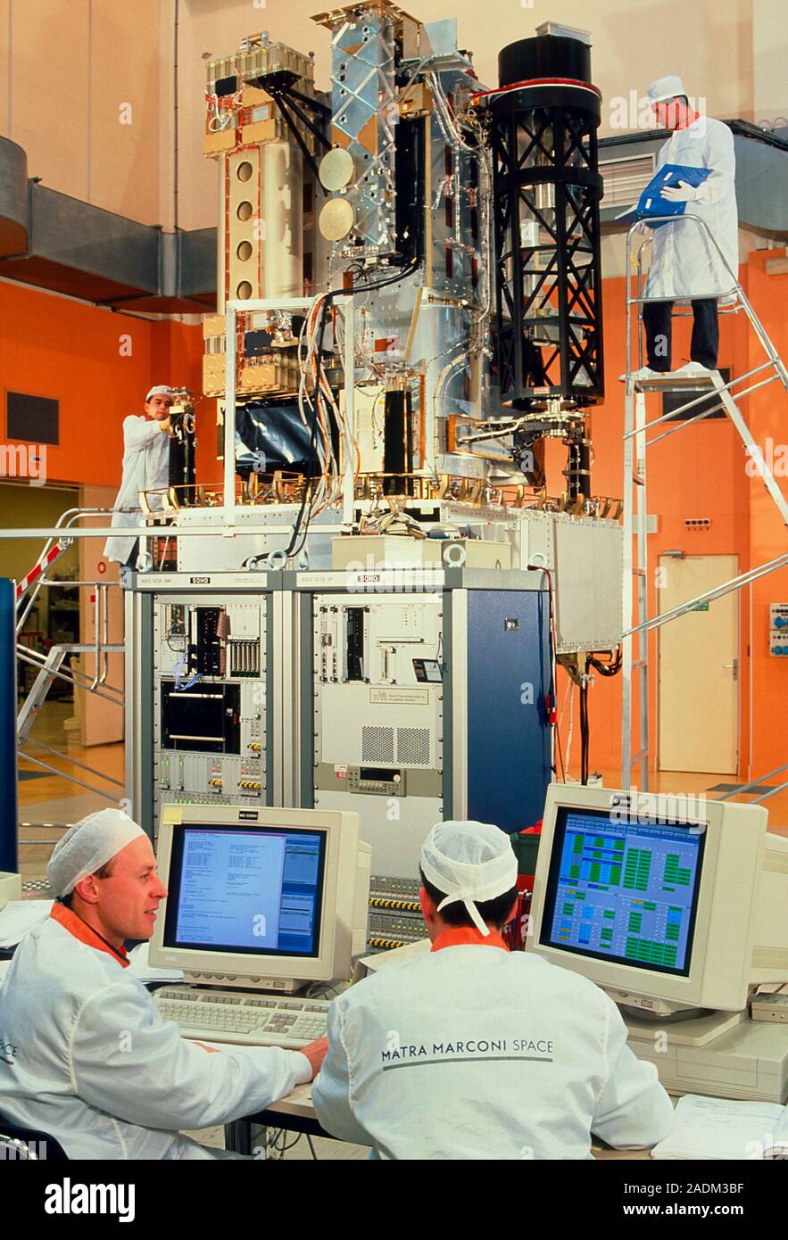 SOHO solar physics spacecraft. Technicians running tests on the Solar ...