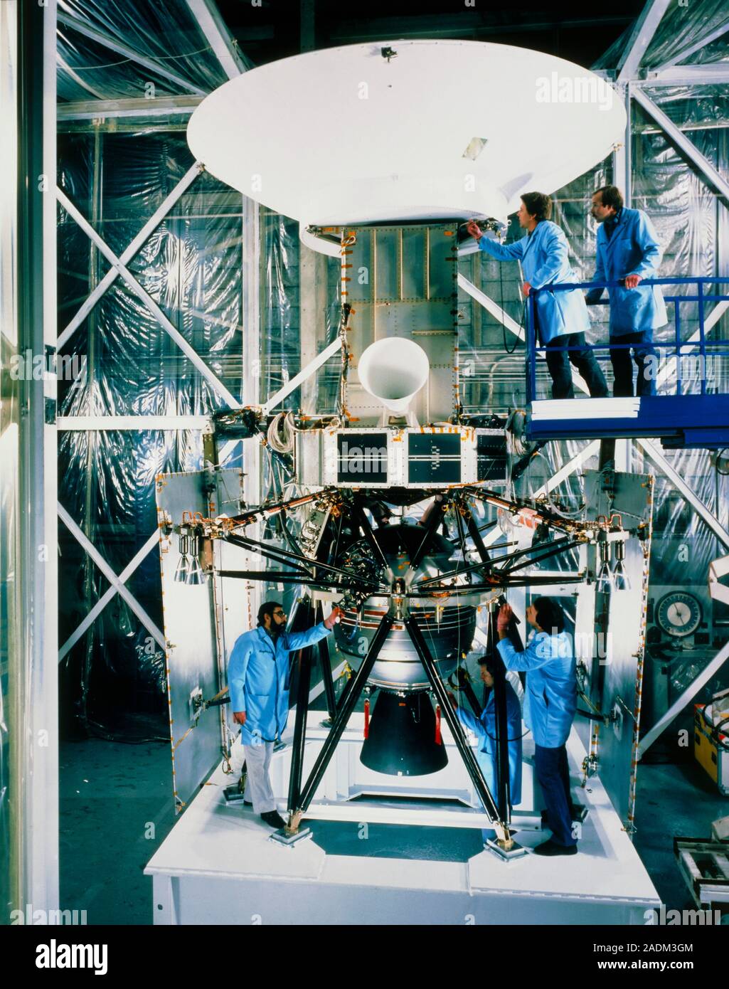 Technicians examine the Magellan spacecraft, which was launched from ...