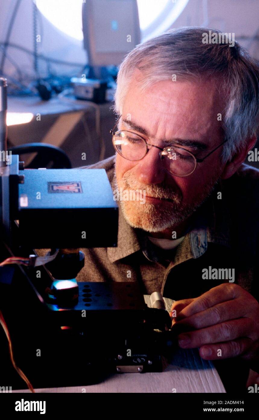 Testing a microscope for use on Mars. Researcher using a microscope to ...