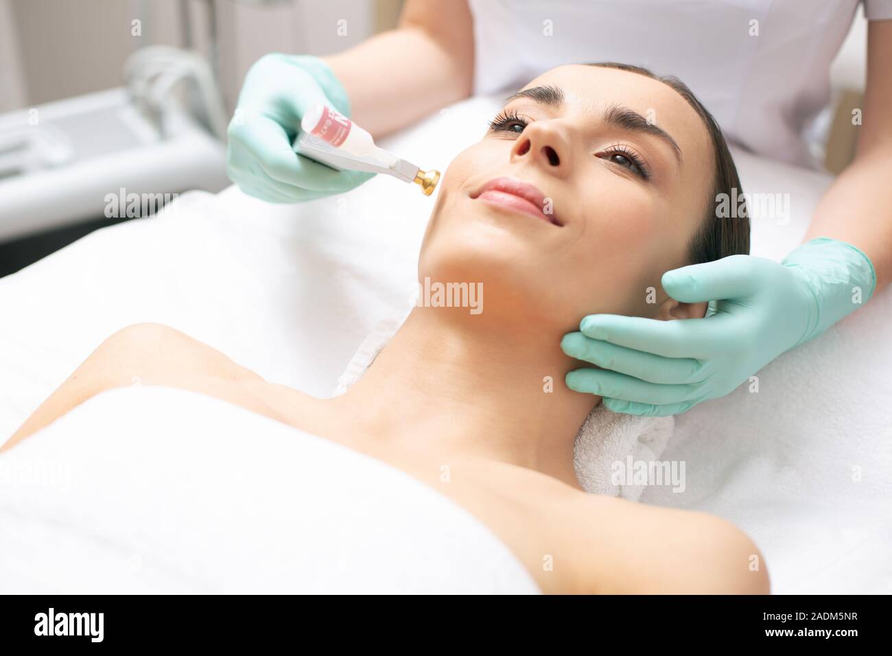Dermatologist reducing inflammation on the skin of smiling woman Stock ...
