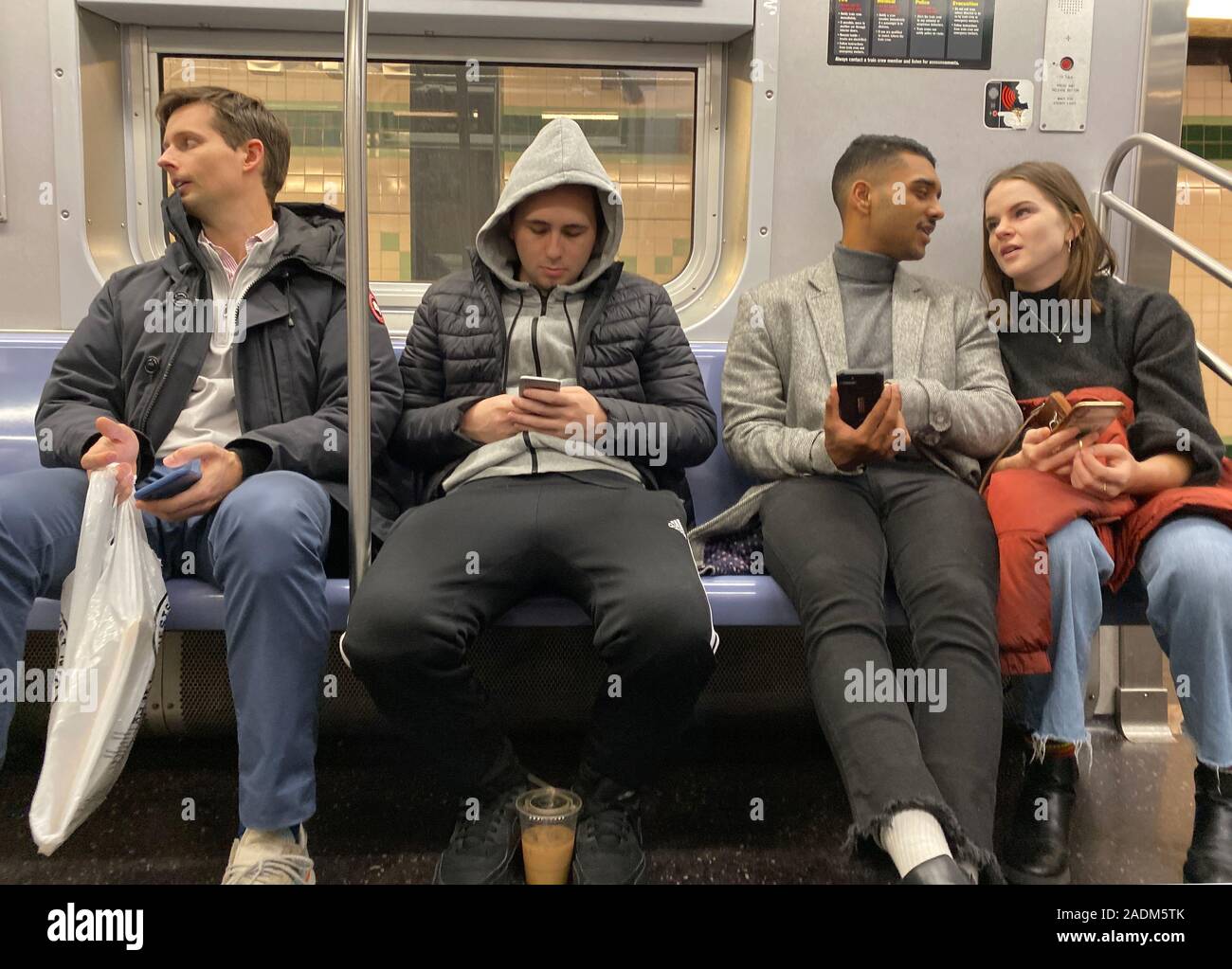 Young people riding a subway train in Brookjlyn, New York City Stock ...