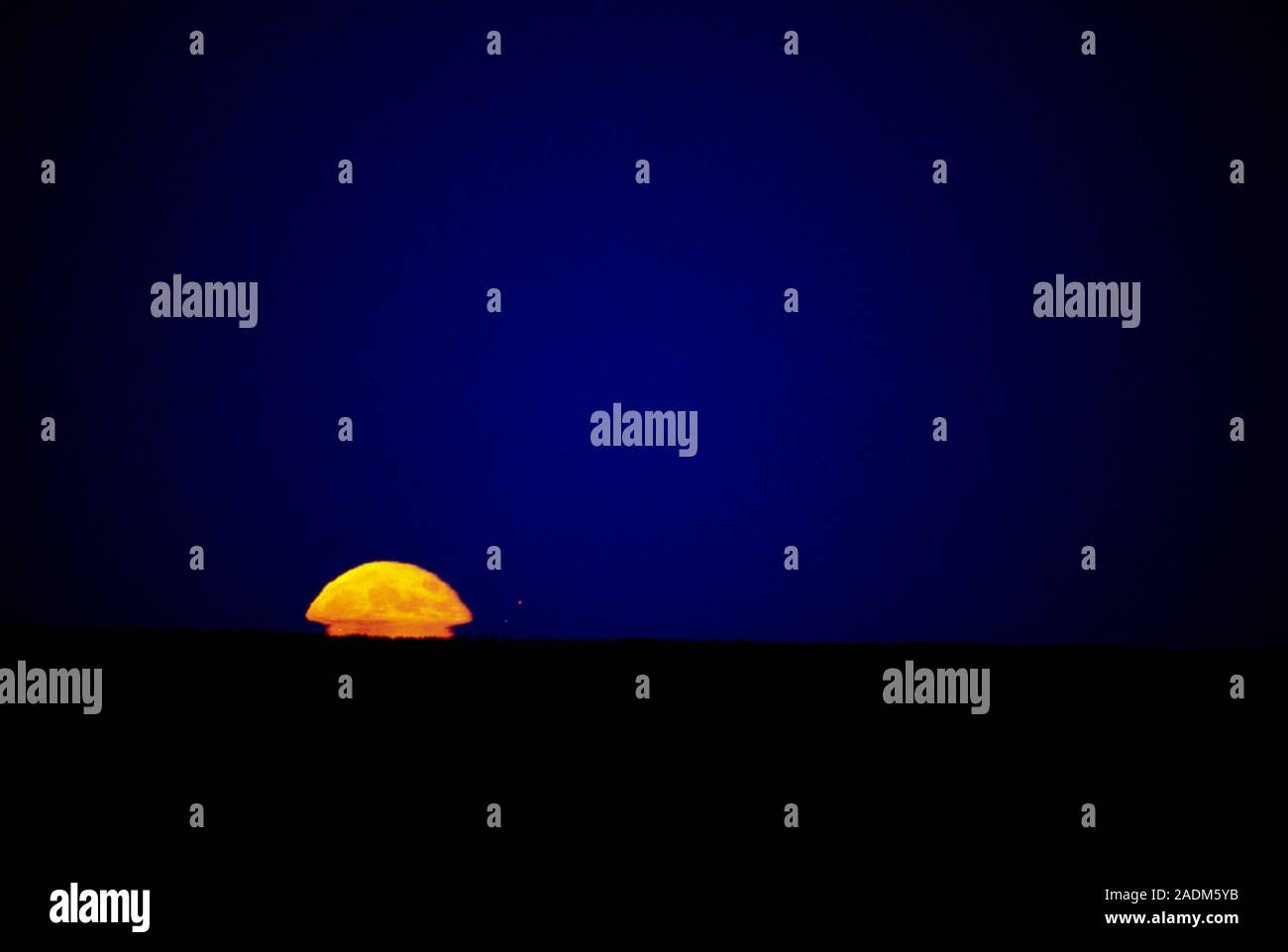 Distorted Moon at the horizon. The distortion is caused by the ...