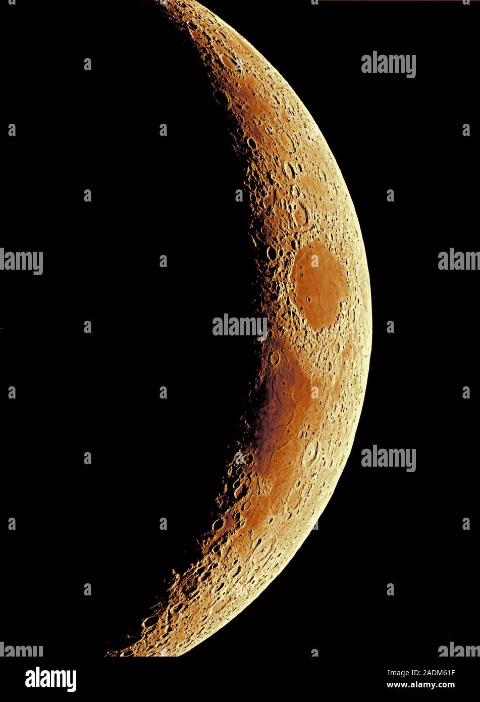 Crescent Moon. Coloured optical image of a waxing crescent Moon. Two ...
