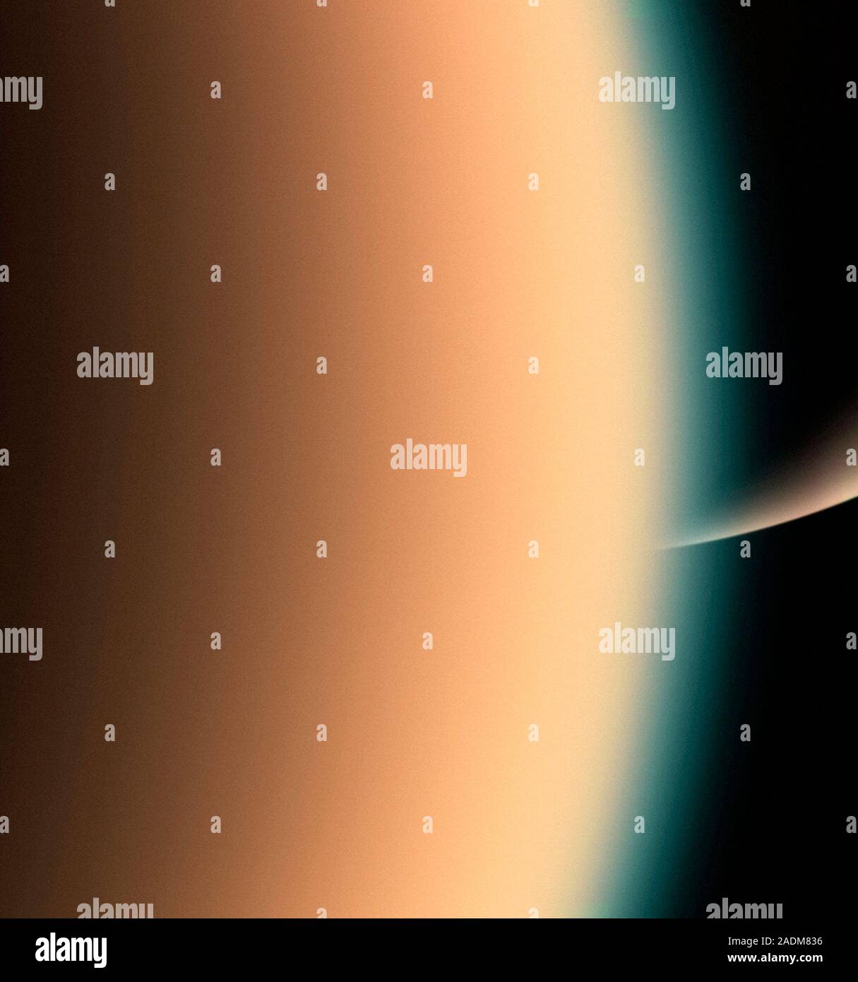 Saturn's moon Titan, Cassini image. Titan's atmosphere (orange) is at ...