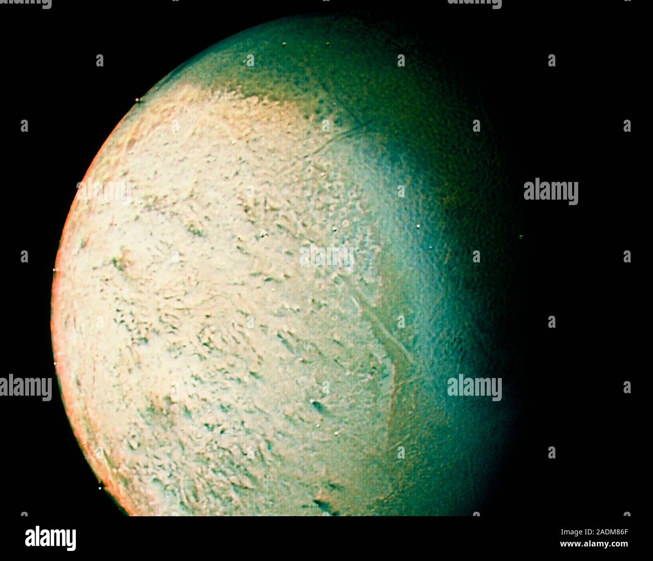 Colour-enhanced Voyager 2 image of Neptune's largest moon, Triton. The ...