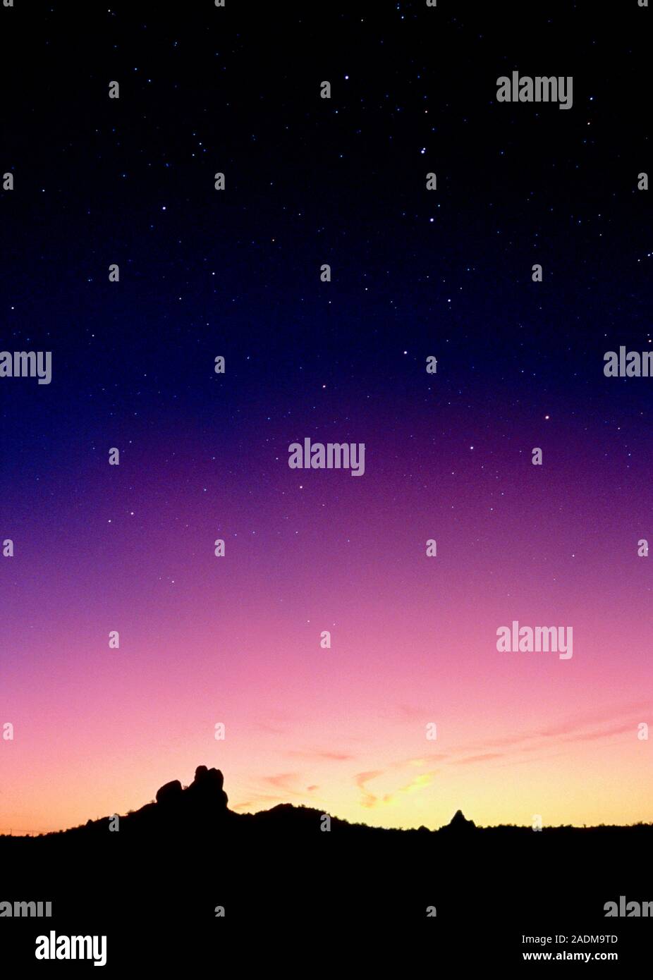 The Plough. Last light of dusk silhouettes rock formations as stars of ...