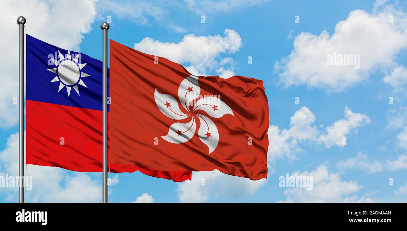 Taiwan and Hong Kong flag waving in the wind against white cloudy blue ...