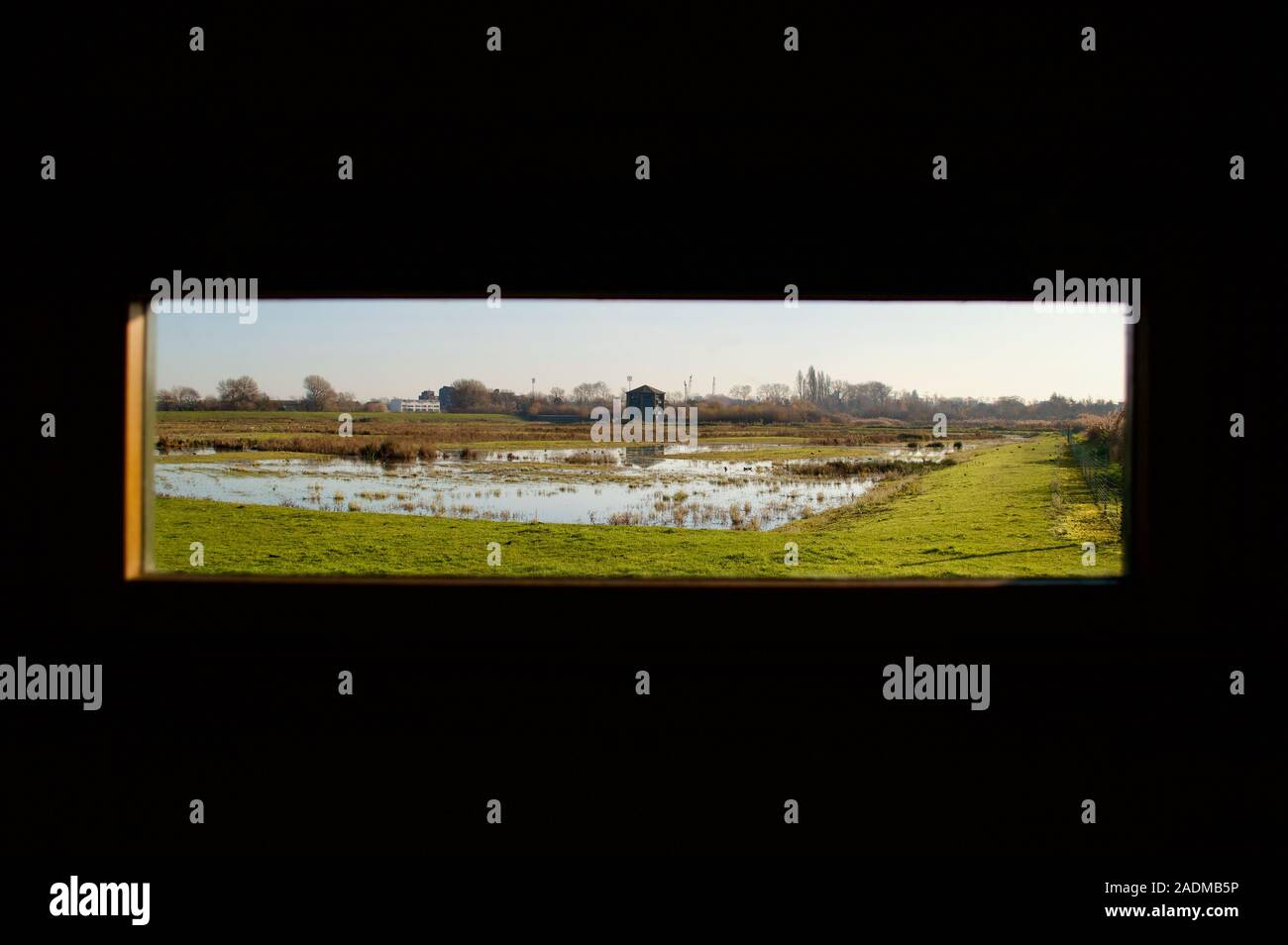 A view through a window at a bird hide at the London Wetland Centre in ...
