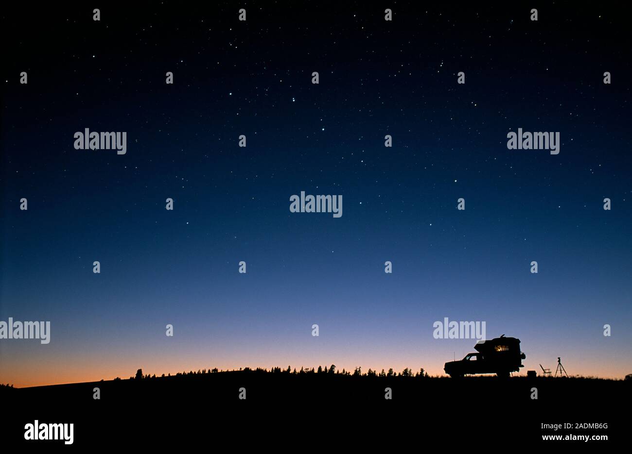 Starry sky. Silhouetted caravan underneath the starry night sky ...