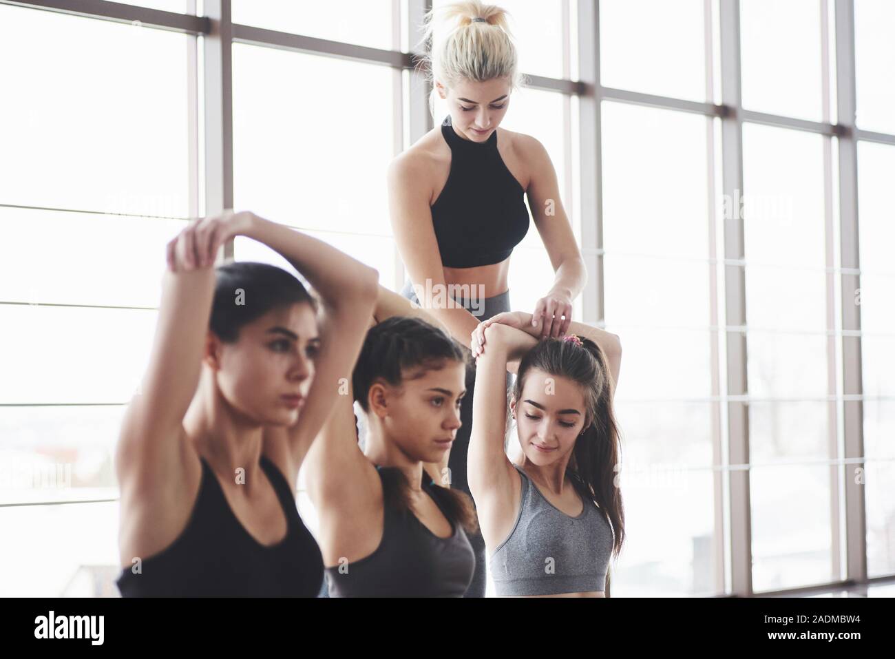 Some new poses. Female trainer learning women how to fitness. Group of ...