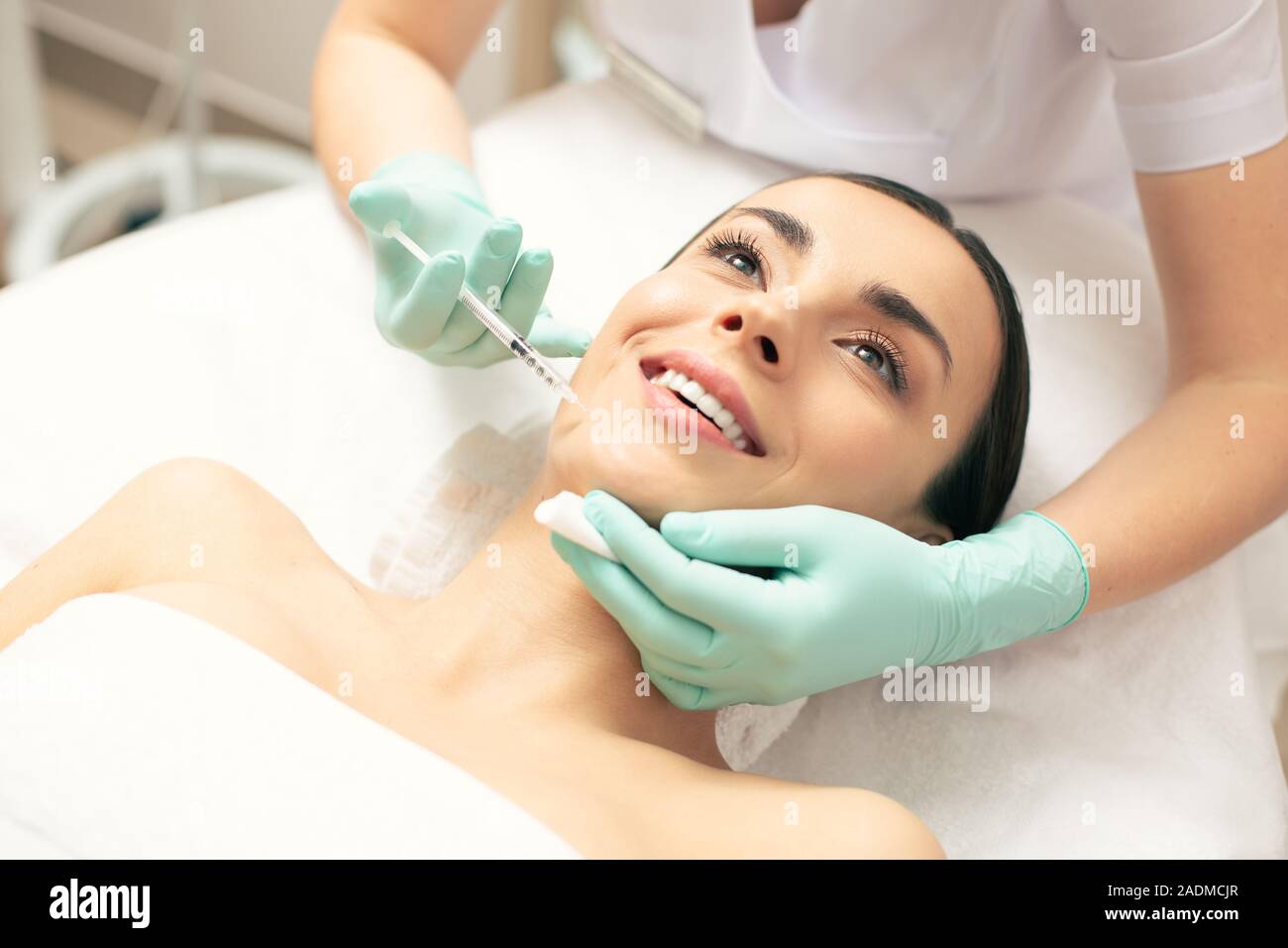 Emotional woman smiling while undergoing skin vitamin injection Stock ...