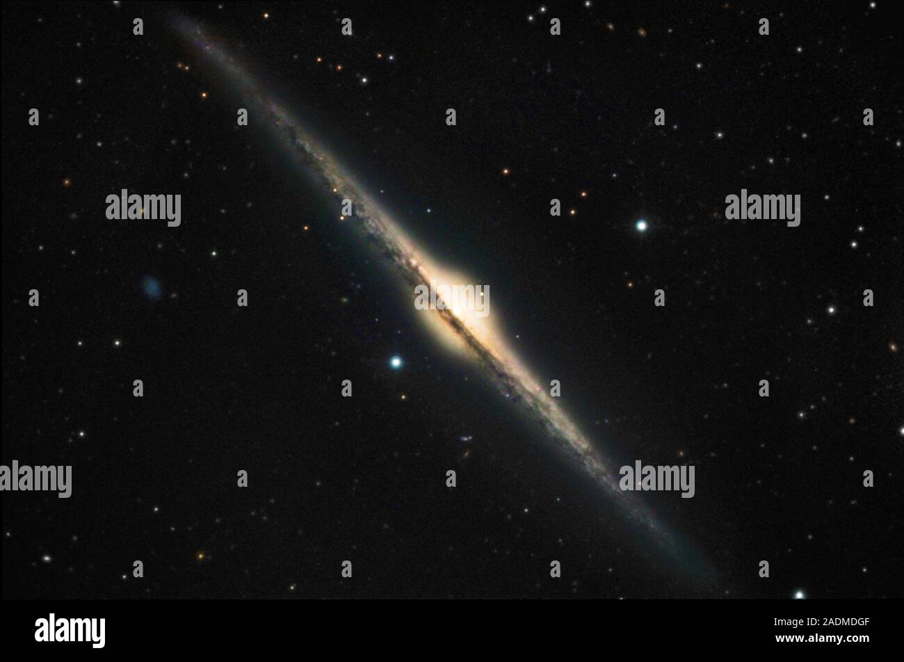Spiral galaxy NGC 4565, optical image. This galaxy is seen exactly edge ...