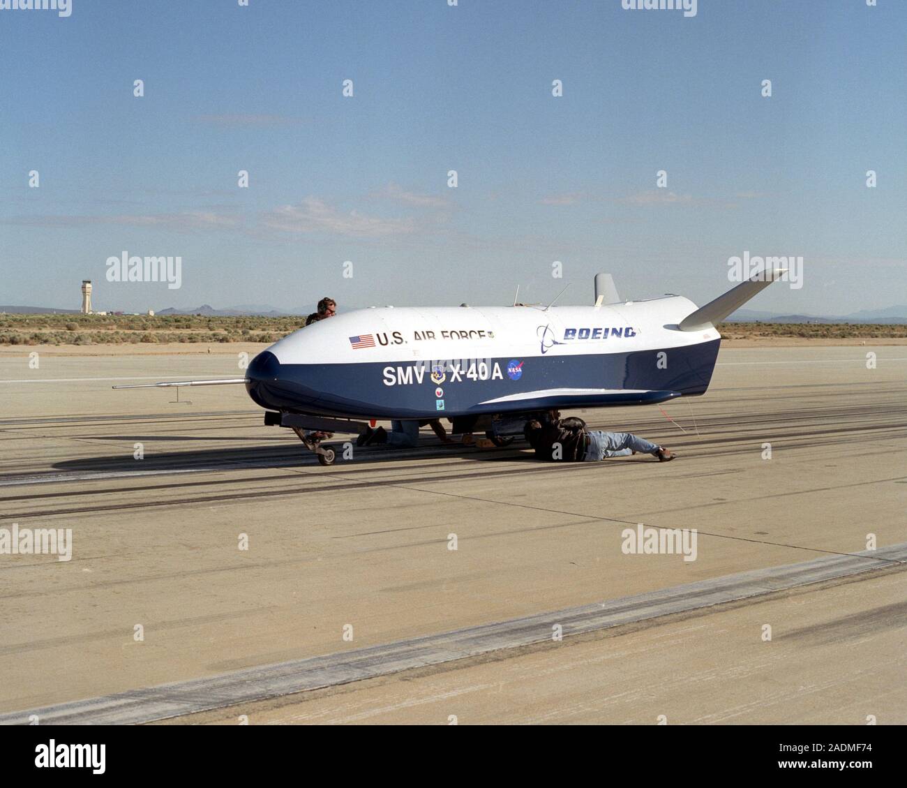 X-40A aircraft. Technicians servicing the robotic X-40A aircraft on a ...