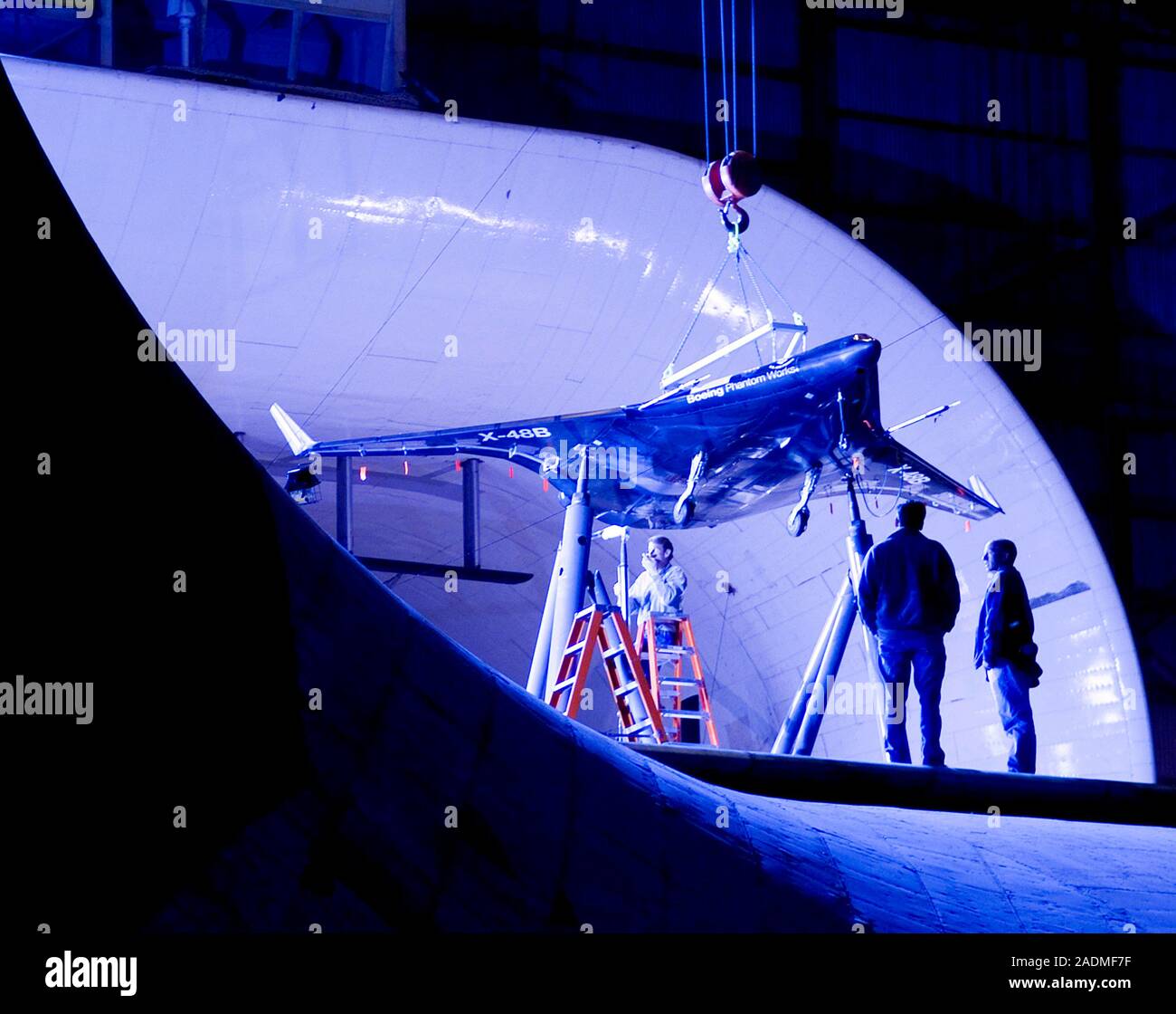 X-48B Blended Wing Body aircraft model. Technicians inspect the sub ...