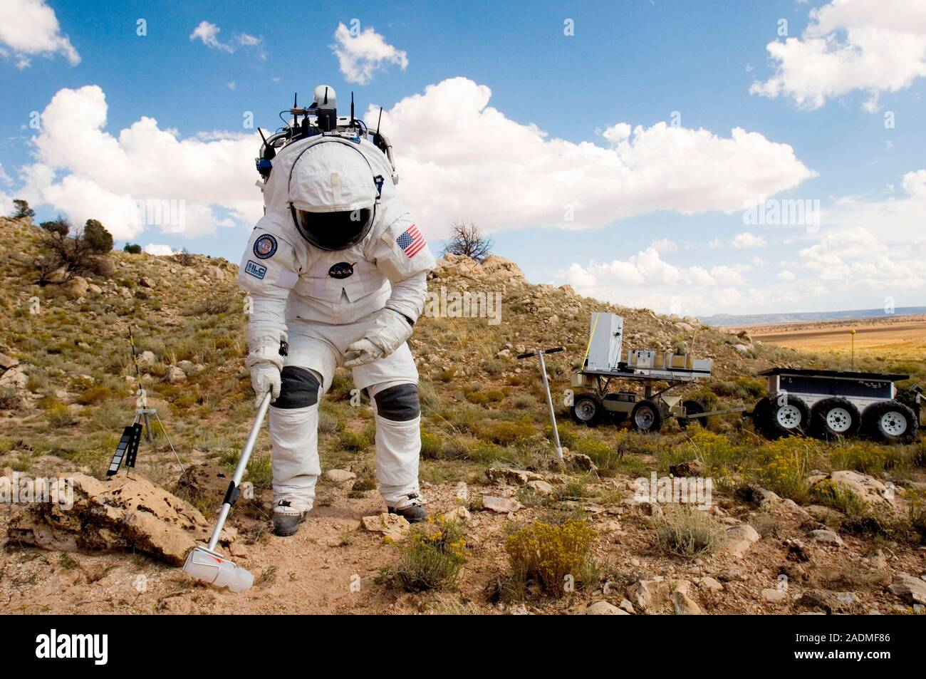 NASA field study. Astronaut collecting a soil sample during a field ...