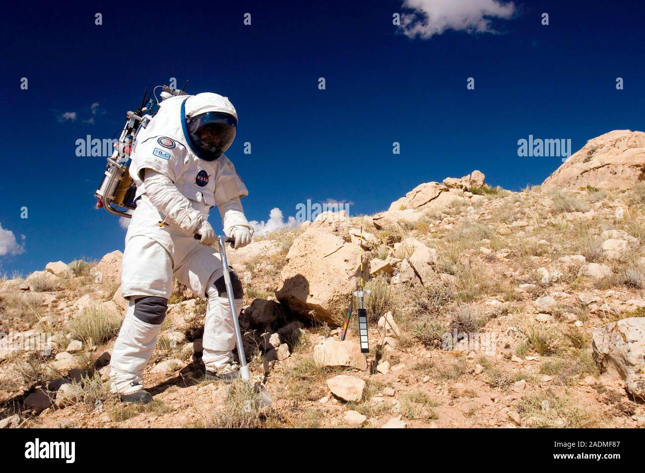 NASA field study. Scientist using a core sampling tool during a field ...