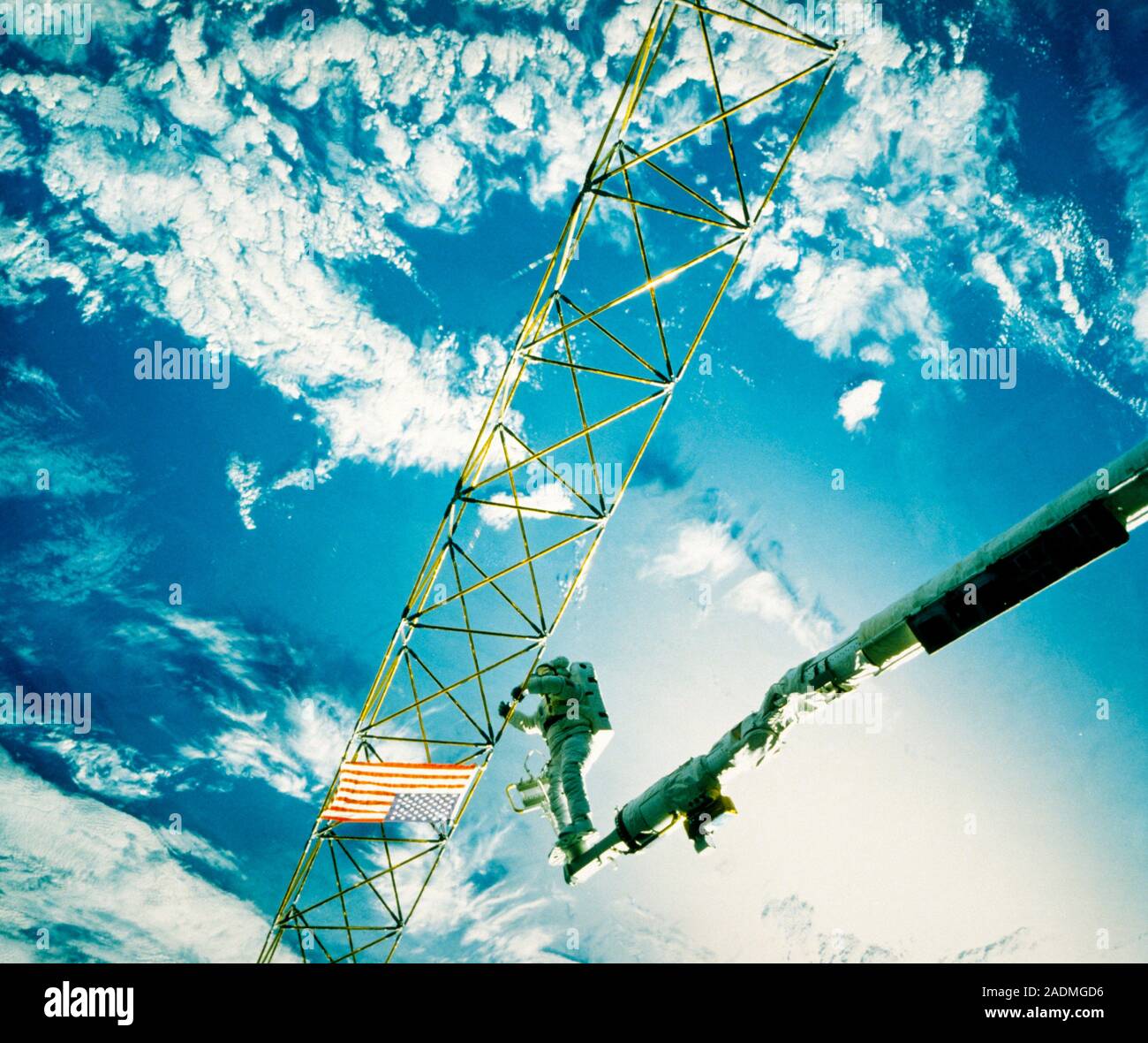 Astronaut Sherwood C. Spring stands on the end of the space shuttle's ...