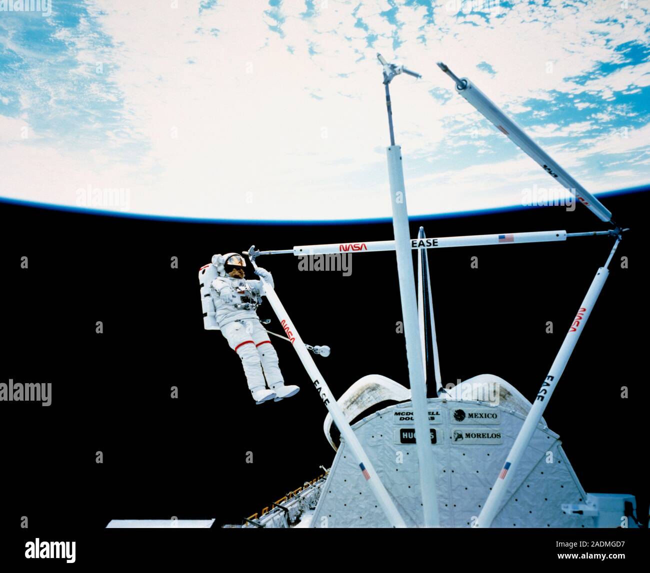 Astronaut Sherwood Spring snaps together beams in the EASE experiment ...